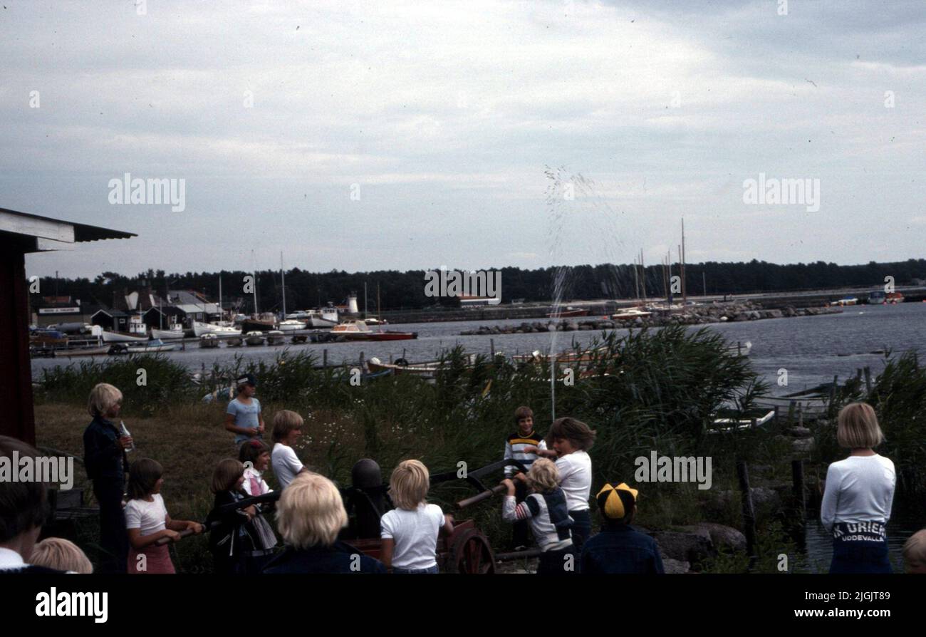 Children play with a fire sprayer during Culture Day in Hällevik Stock ...