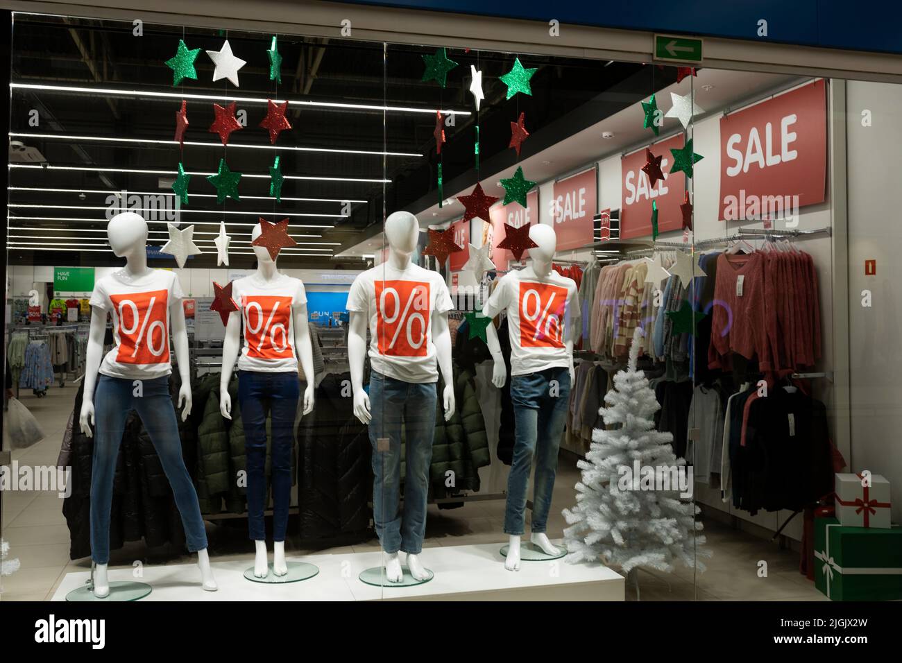 showcase of a clothing store with mannequins dressed in a t-shirt with ...