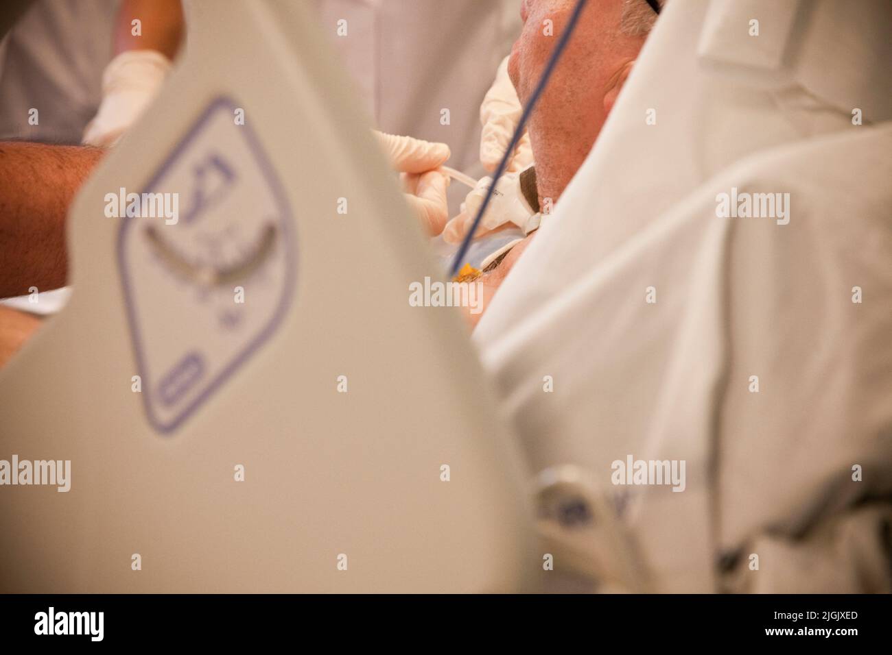 Doctors oscultate through the trachea a patient with Charcot s disease ...