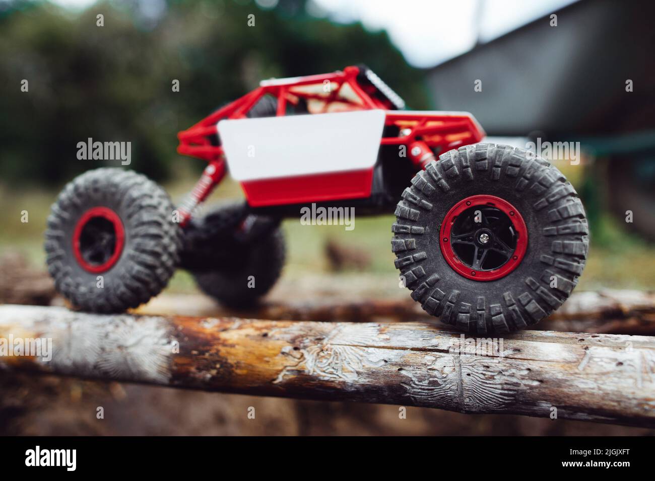Crawler driving on wooden beams side view Stock Photo - Alamy