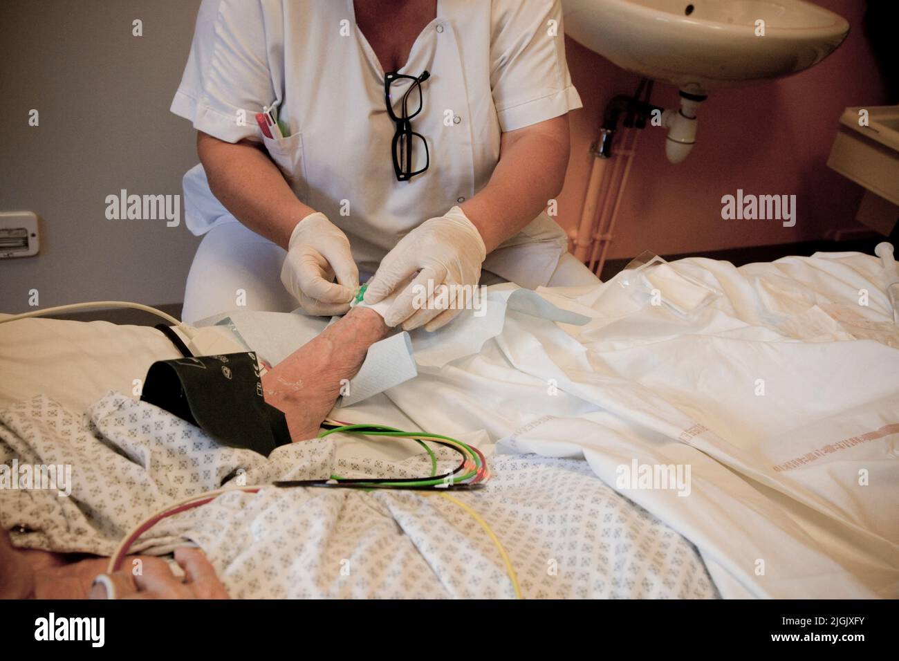 A nurse takes a blood sample from a patient, Briancon, France on July ...