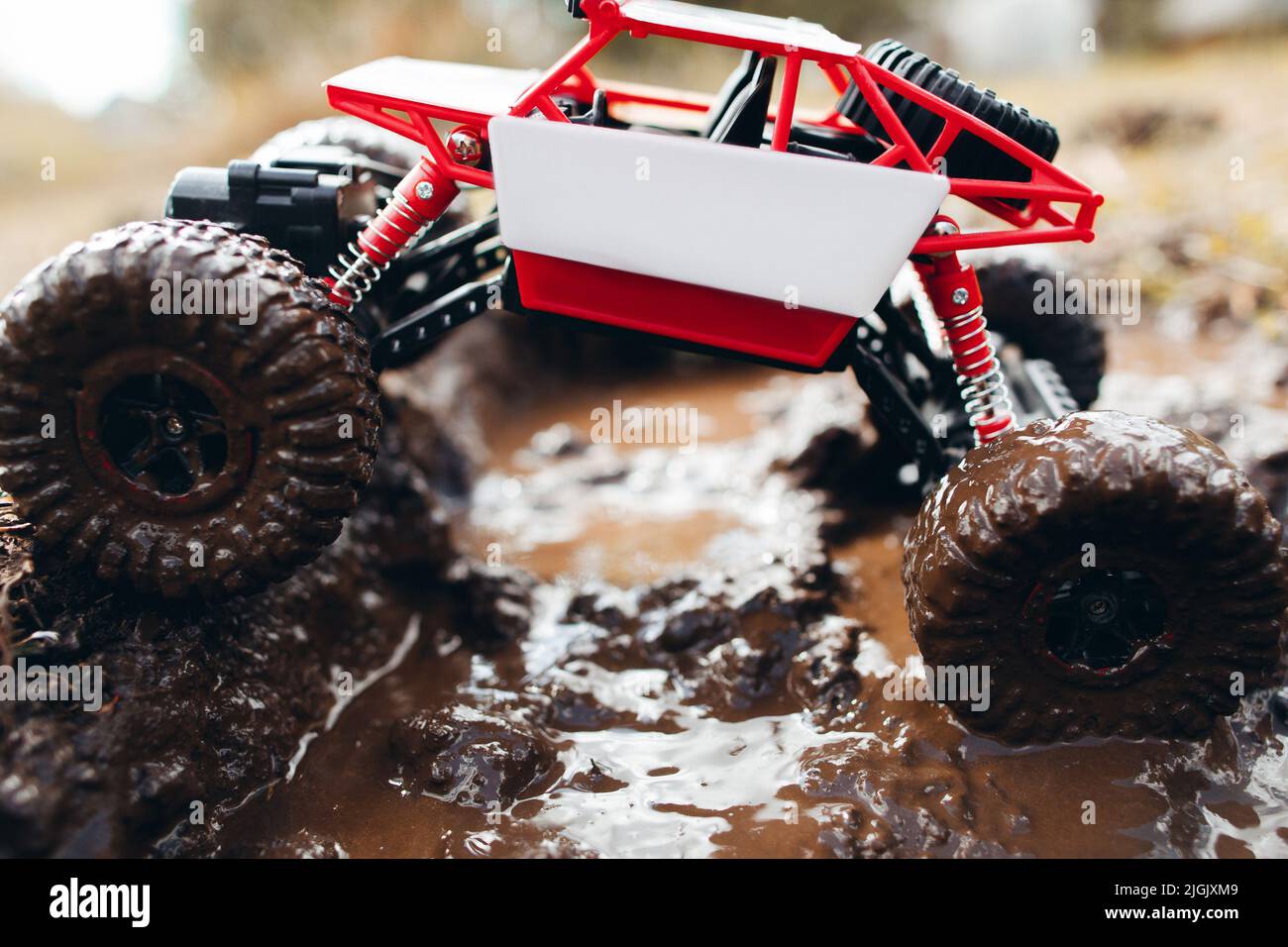 Toy suv riding through mud, side view Stock Photo - Alamy
