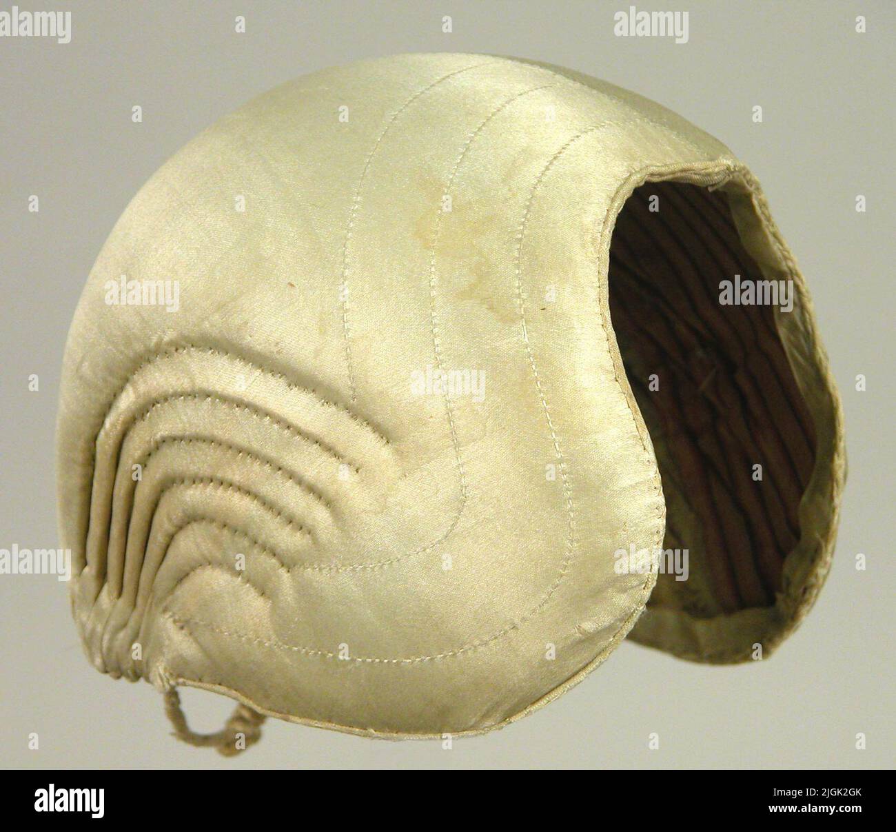 Bindmössa A binding cap of light gray atlas. 6 folds on each side of ...