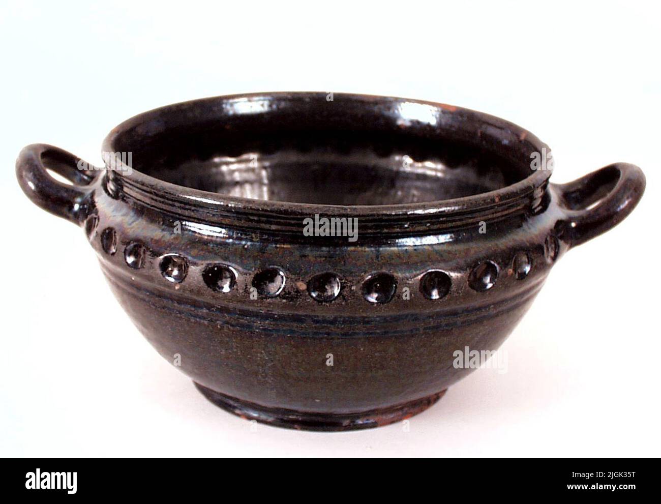 Terrin Terrin of earthenware. Black glazed in and outside with two ears ...