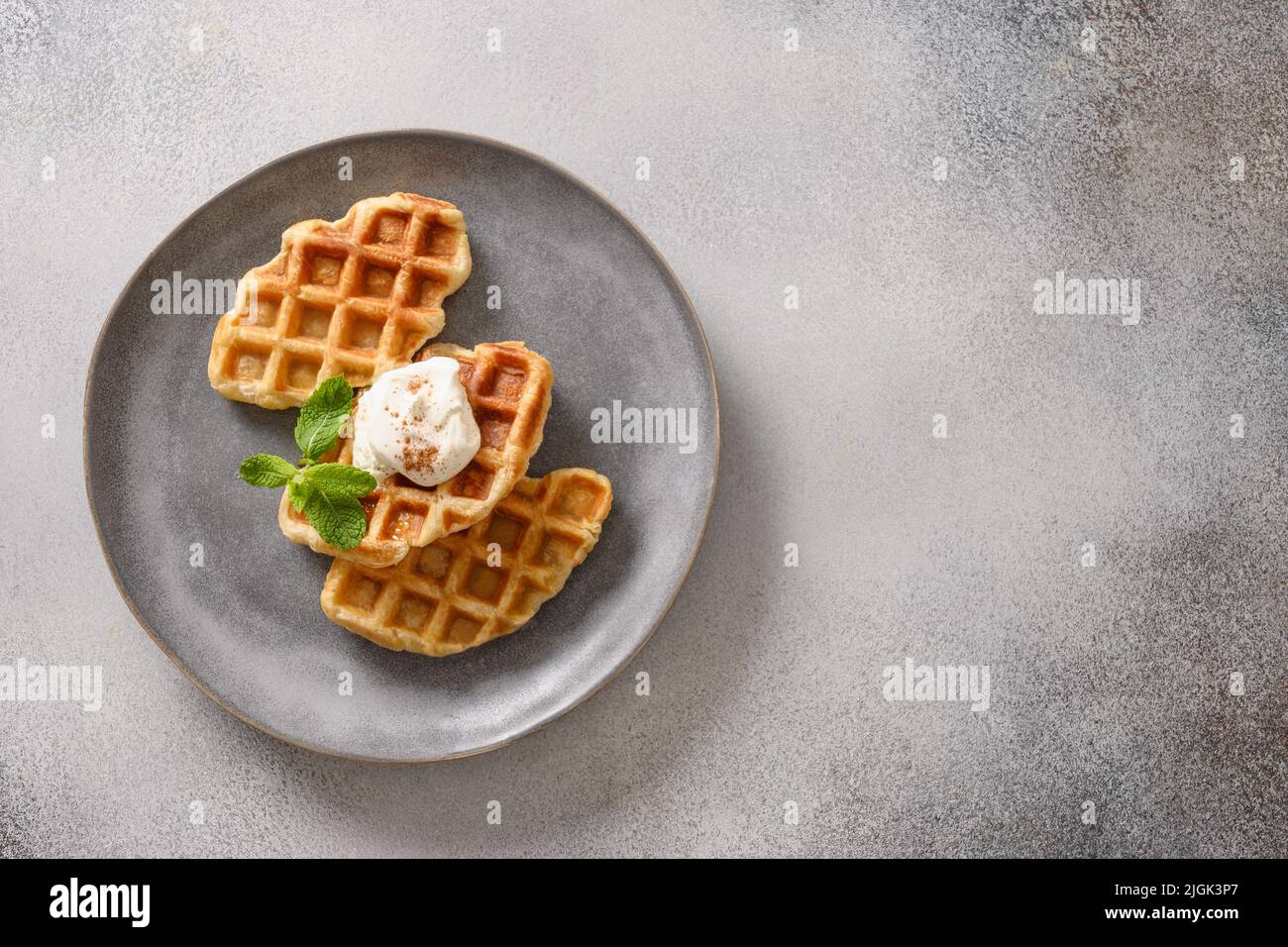 Trendy delicious croffles on gray plate. Croissant as waffle Stock ...