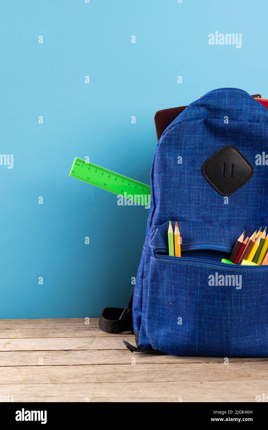 Image of school supplies, notebook, ruler, paper clips on blue ...