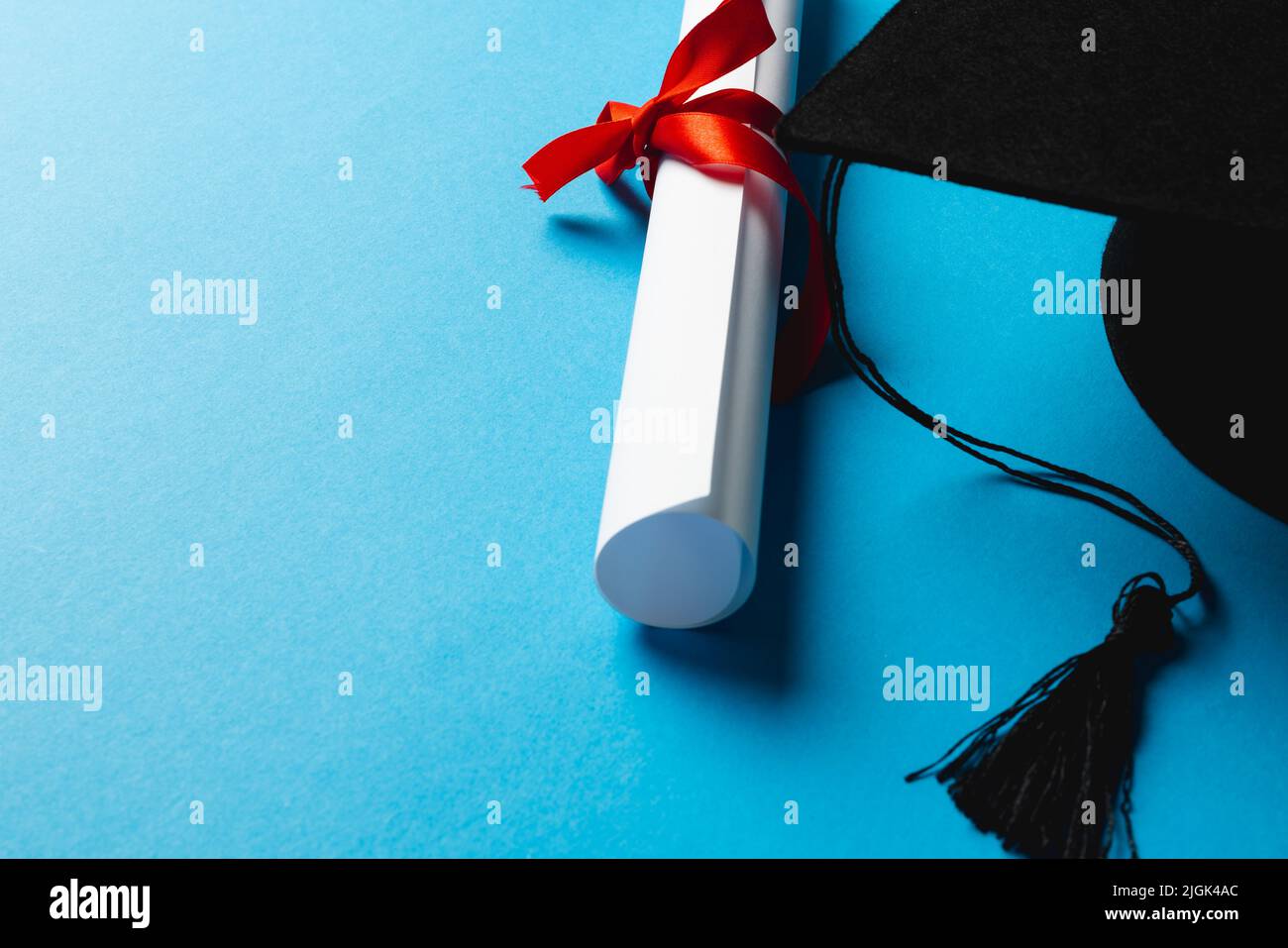 Image of graduation hat and diploma on blue surface Stock Photo - Alamy