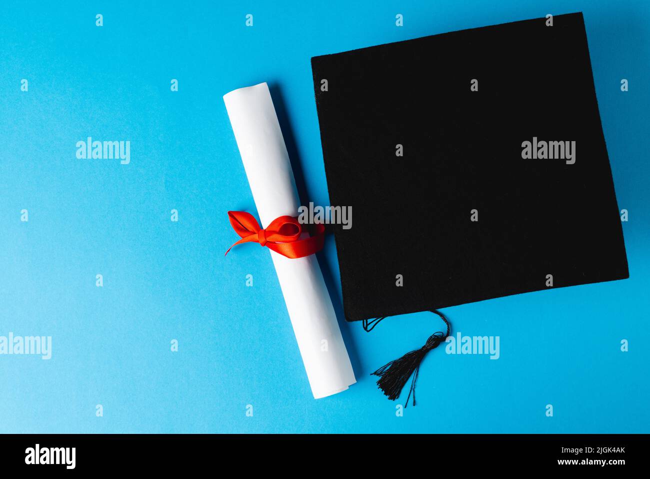 Image of graduation hat and diploma on blue surface Stock Photo - Alamy