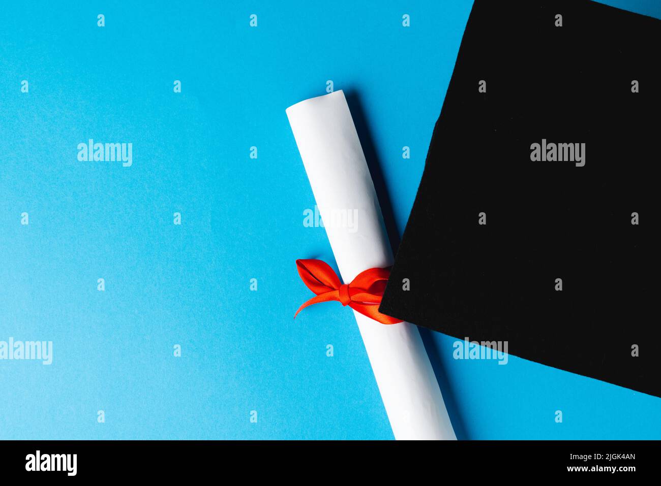 Image of graduation hat and diploma on blue surface Stock Photo - Alamy
