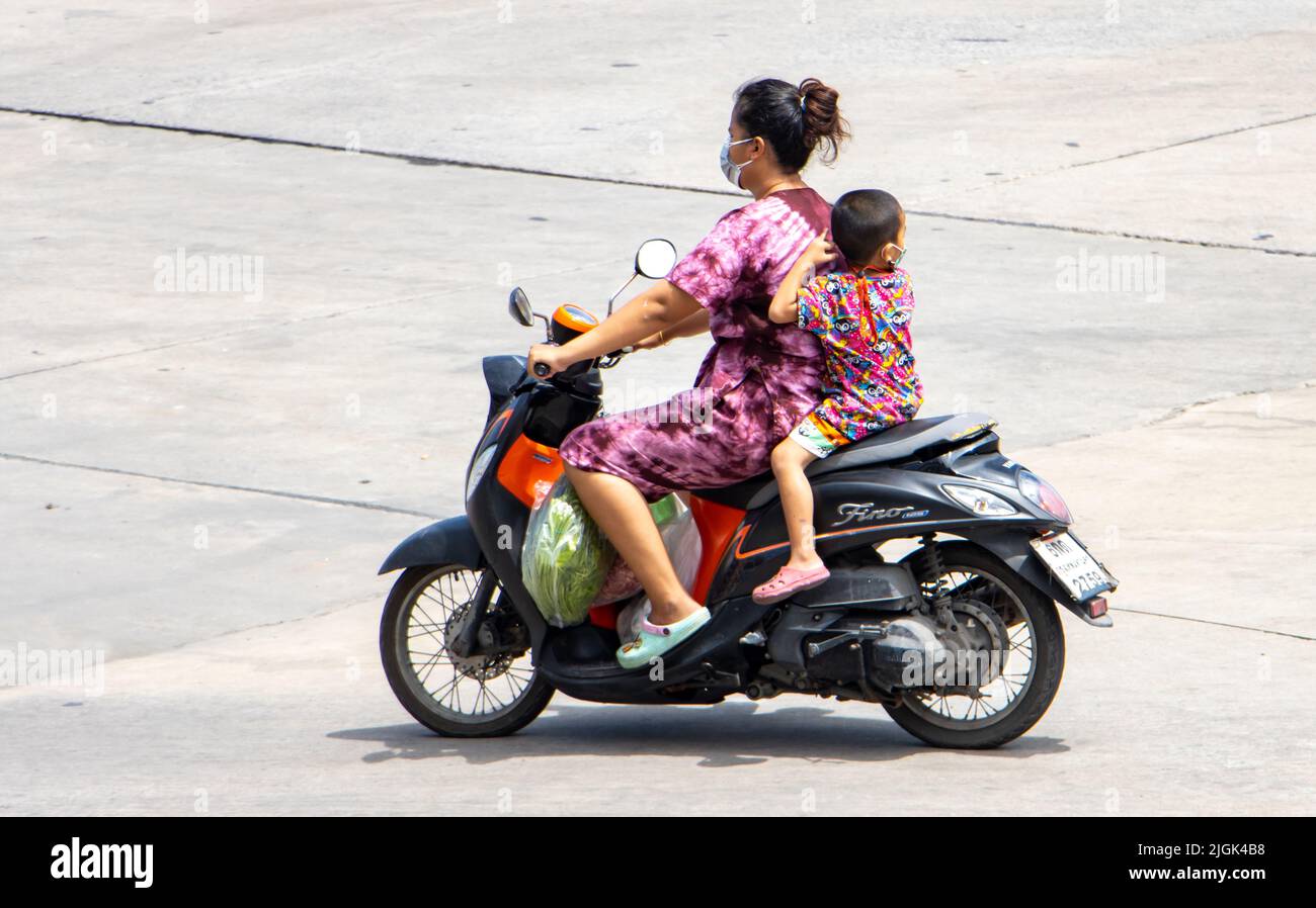 SAMUT PRAKAN, THAILAND, MAR 29 2022, A woman rides boy on a motorcycle ... SAMUT PRAKAN, THAILAND, MAR 29 2022, A woman rides boy on a motorcycle ...