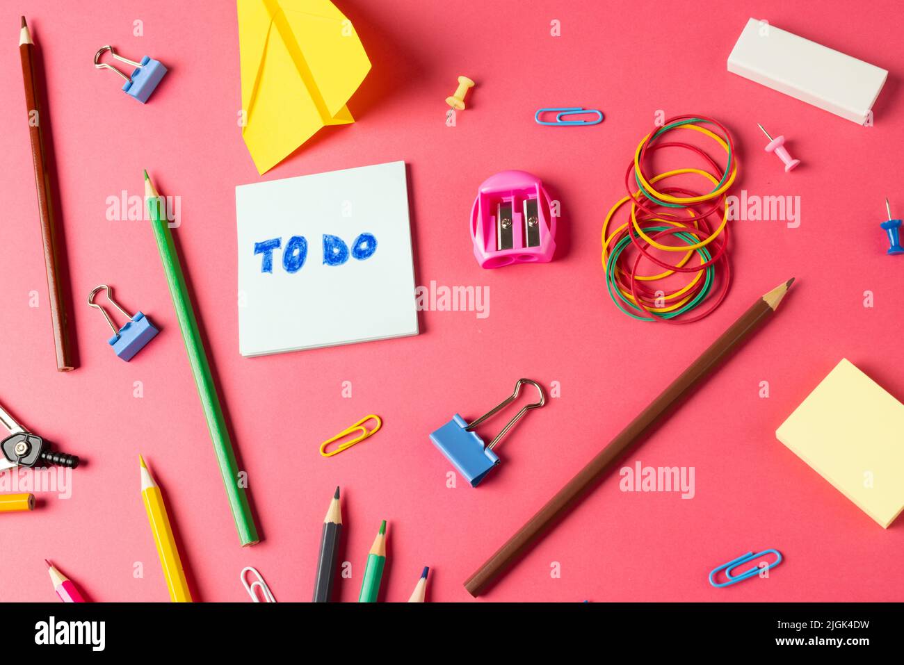 Composition of notebooks, paper plane and school equipment on pink ...
