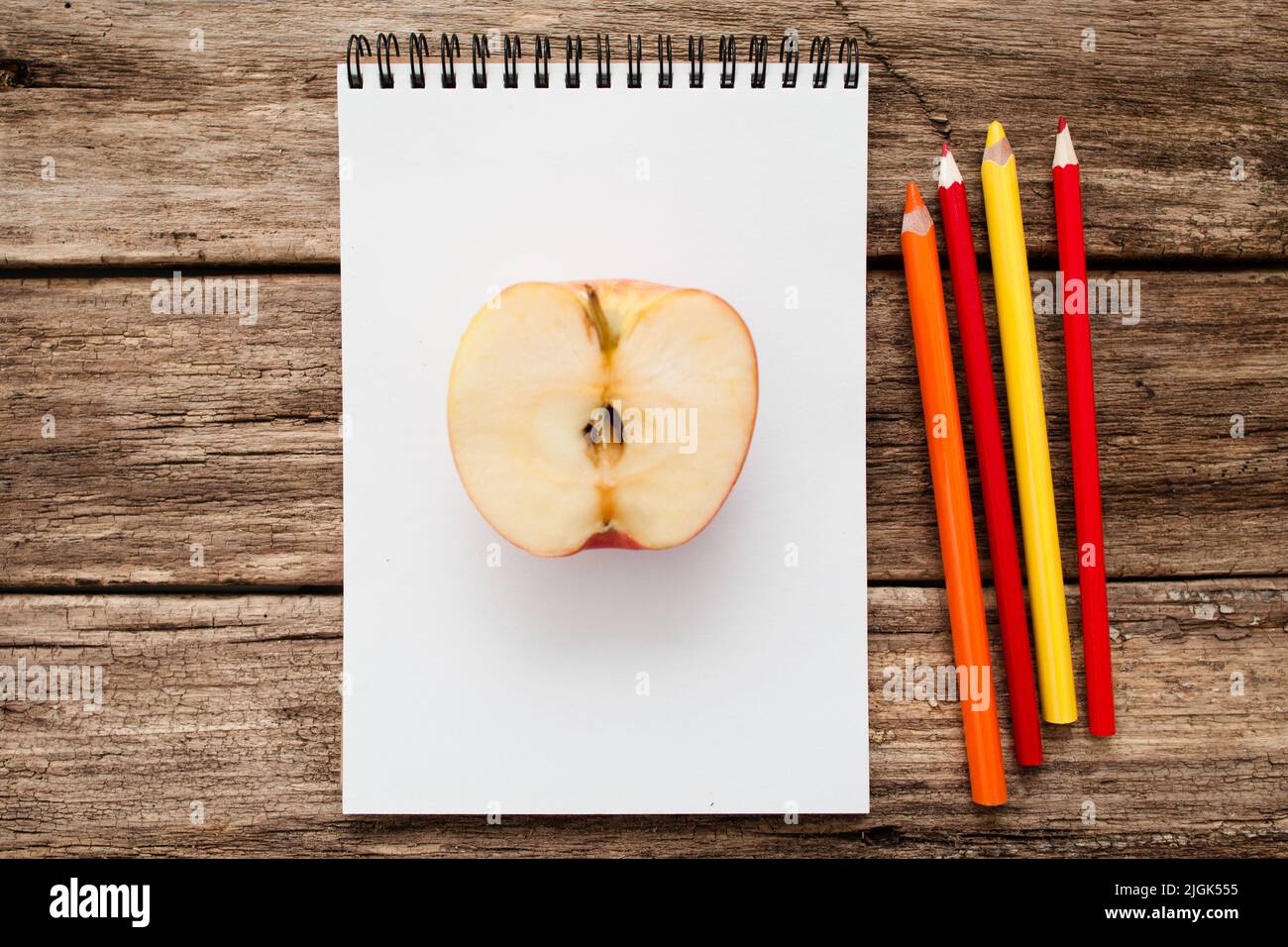 Realistic picture of apple with colorful pencils Stock Photo - Alamy