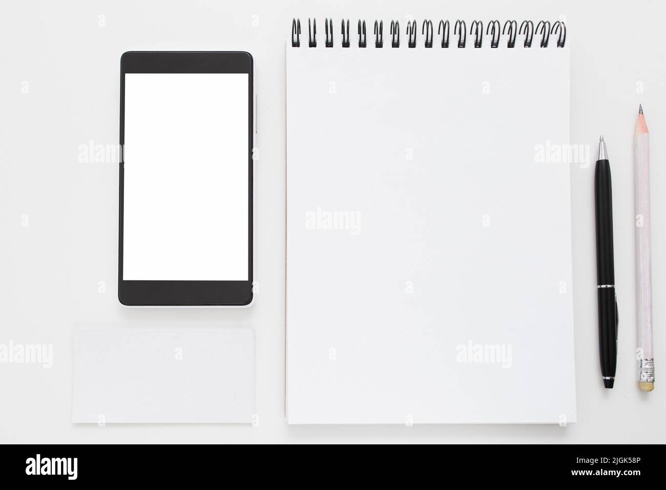 Smartphone and blank notepad flat lay mockup Stock Photo - Alamy