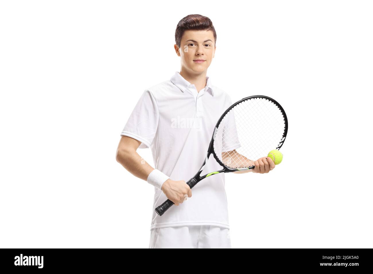 Young male tennis player standing and holding a ball and a racket ...