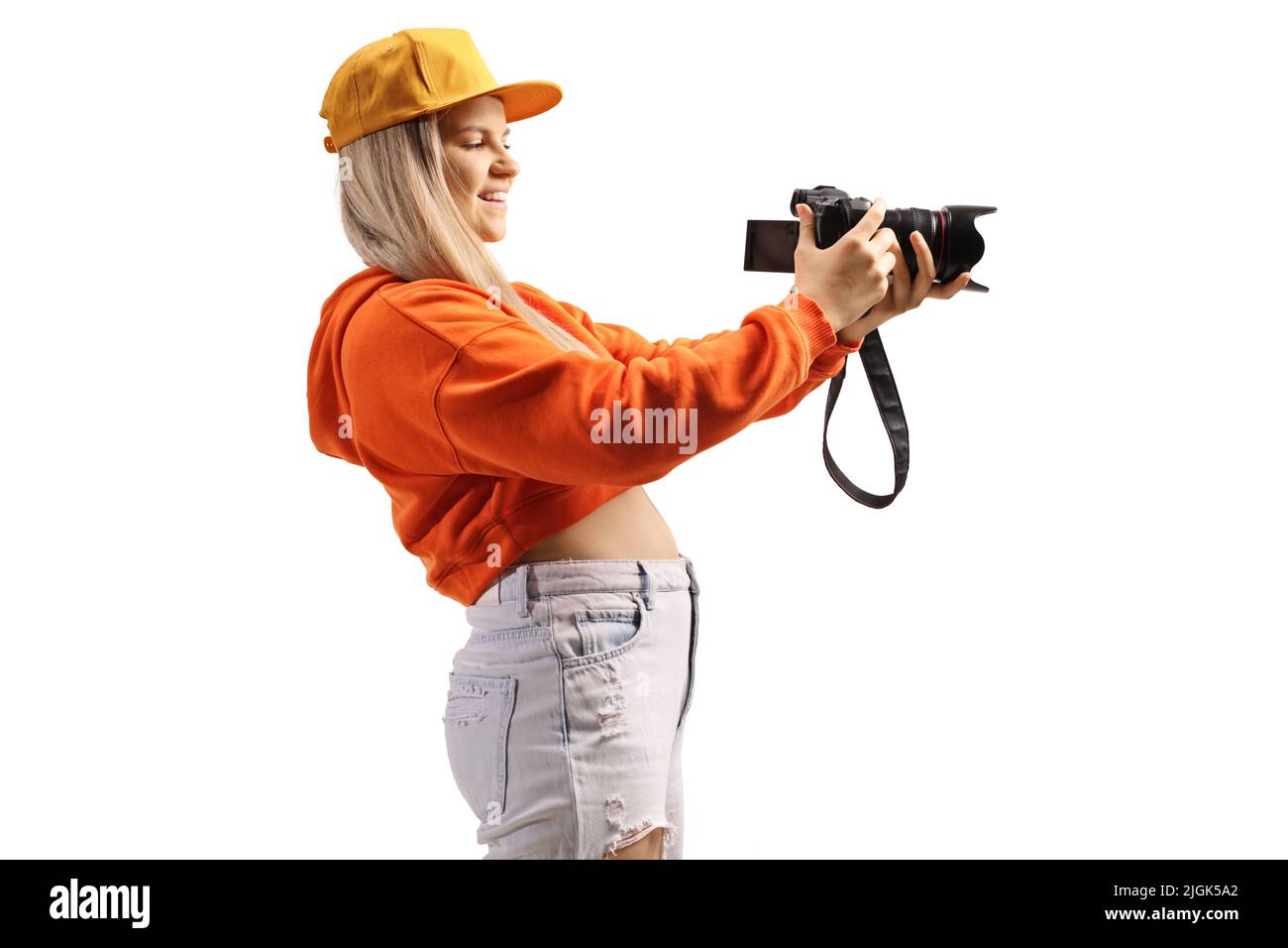 Profile shot of a female teenager recording with a professional camera ...