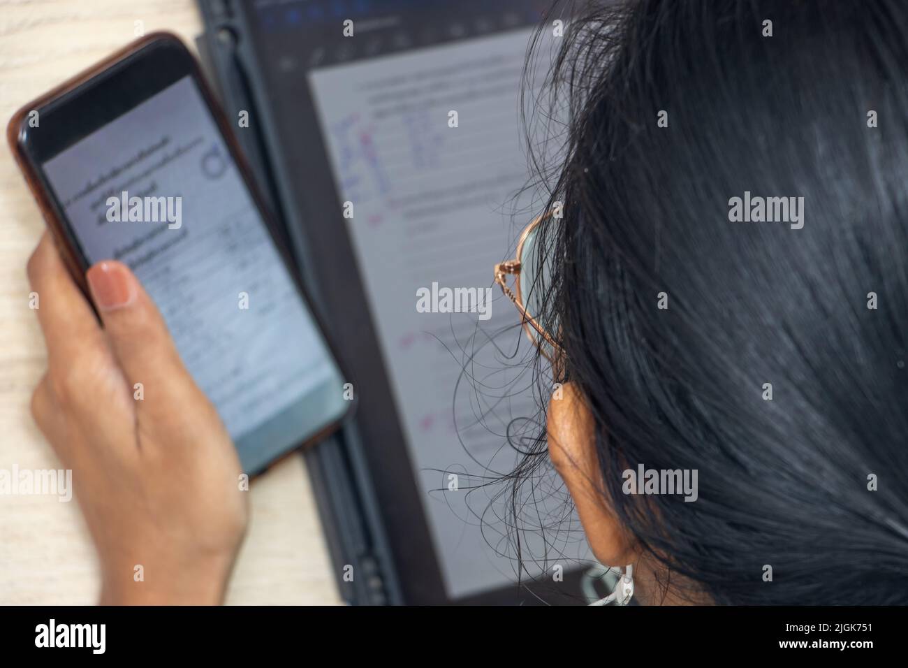 Young woman look on a display of a electronic devices, top view Stock ...
