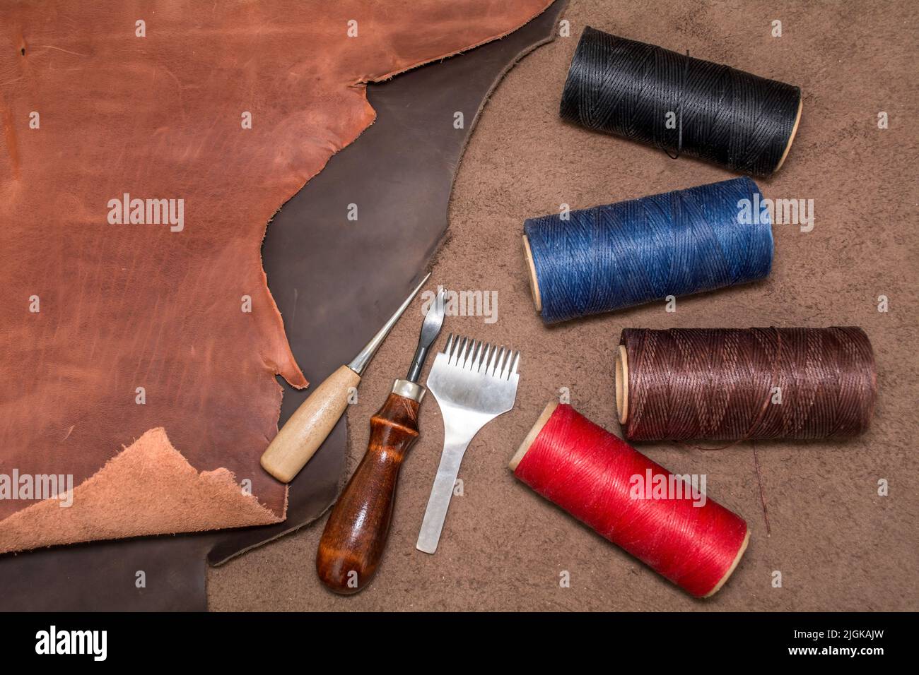 Tools for leather crafting and pieces of brown leather. Manufacture of ...