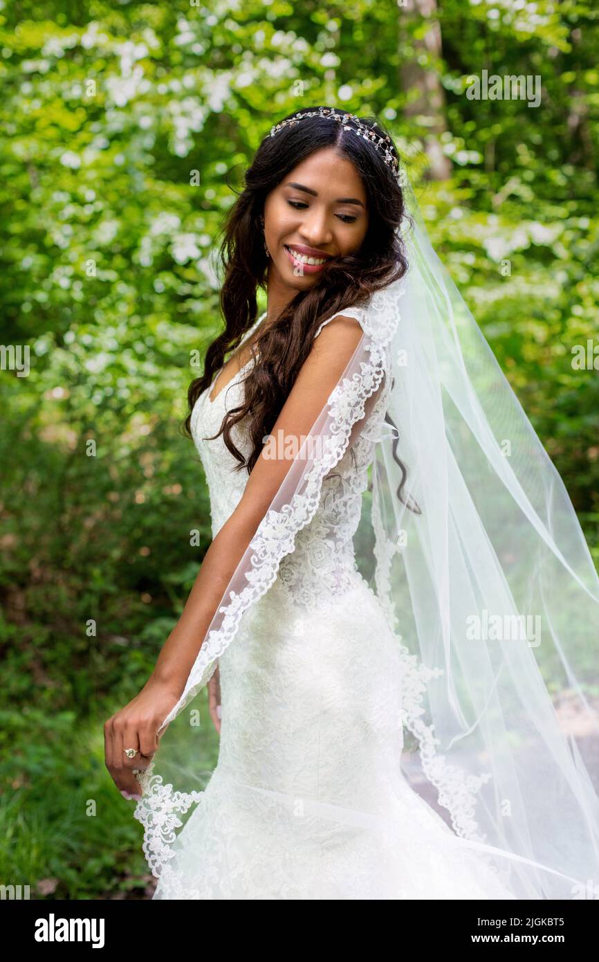 portrait of a beautiful african-american bride standing in white gown ...