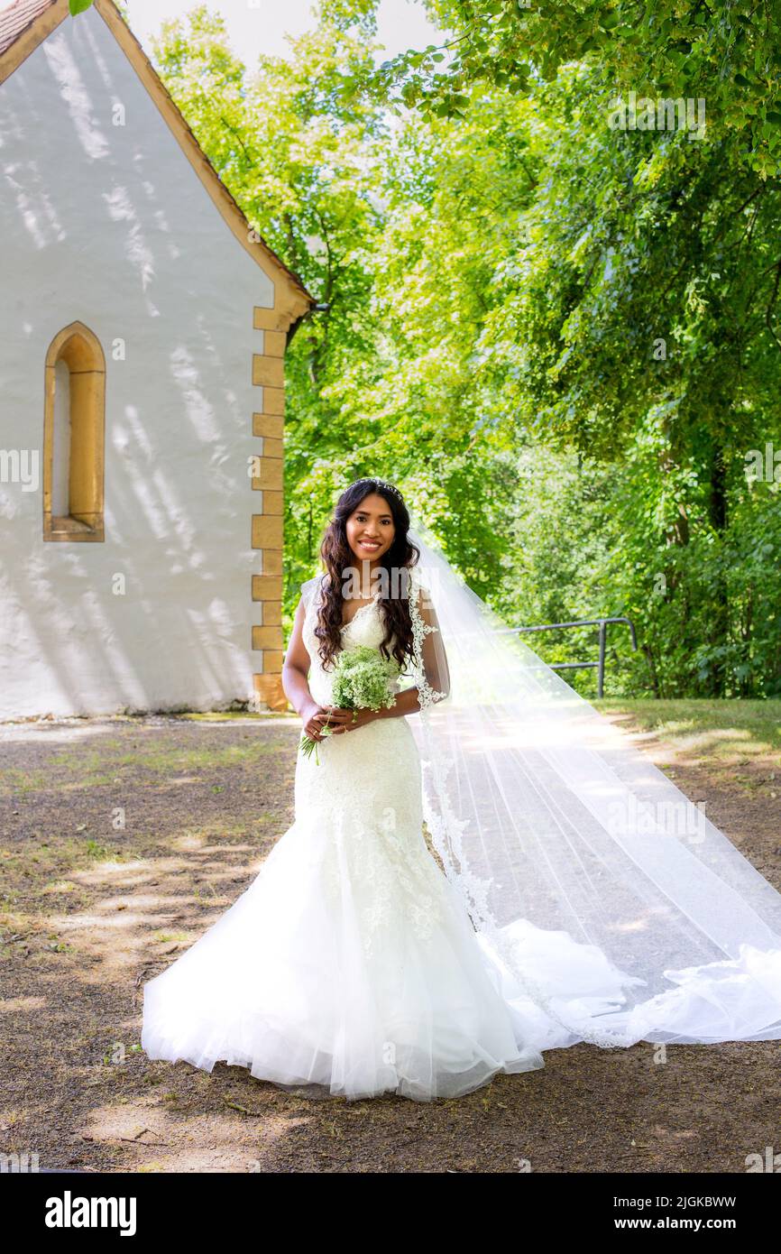 beautiful african-american bride standing in white gown in front of ...
