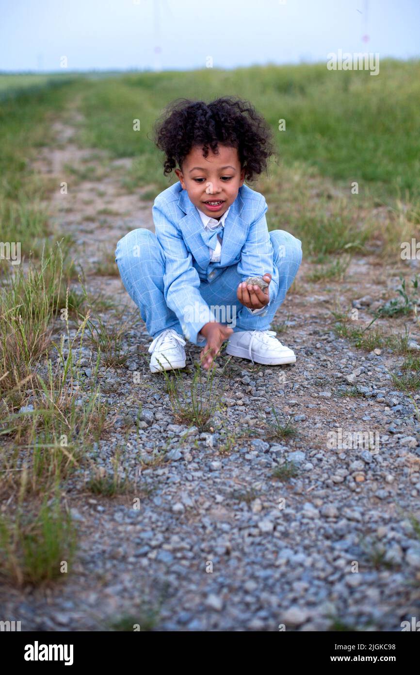 little black boy in blue suit playing outdoors Stock Photo - Alamy little black boy in blue suit playing outdoors Stock Photo - Alamy