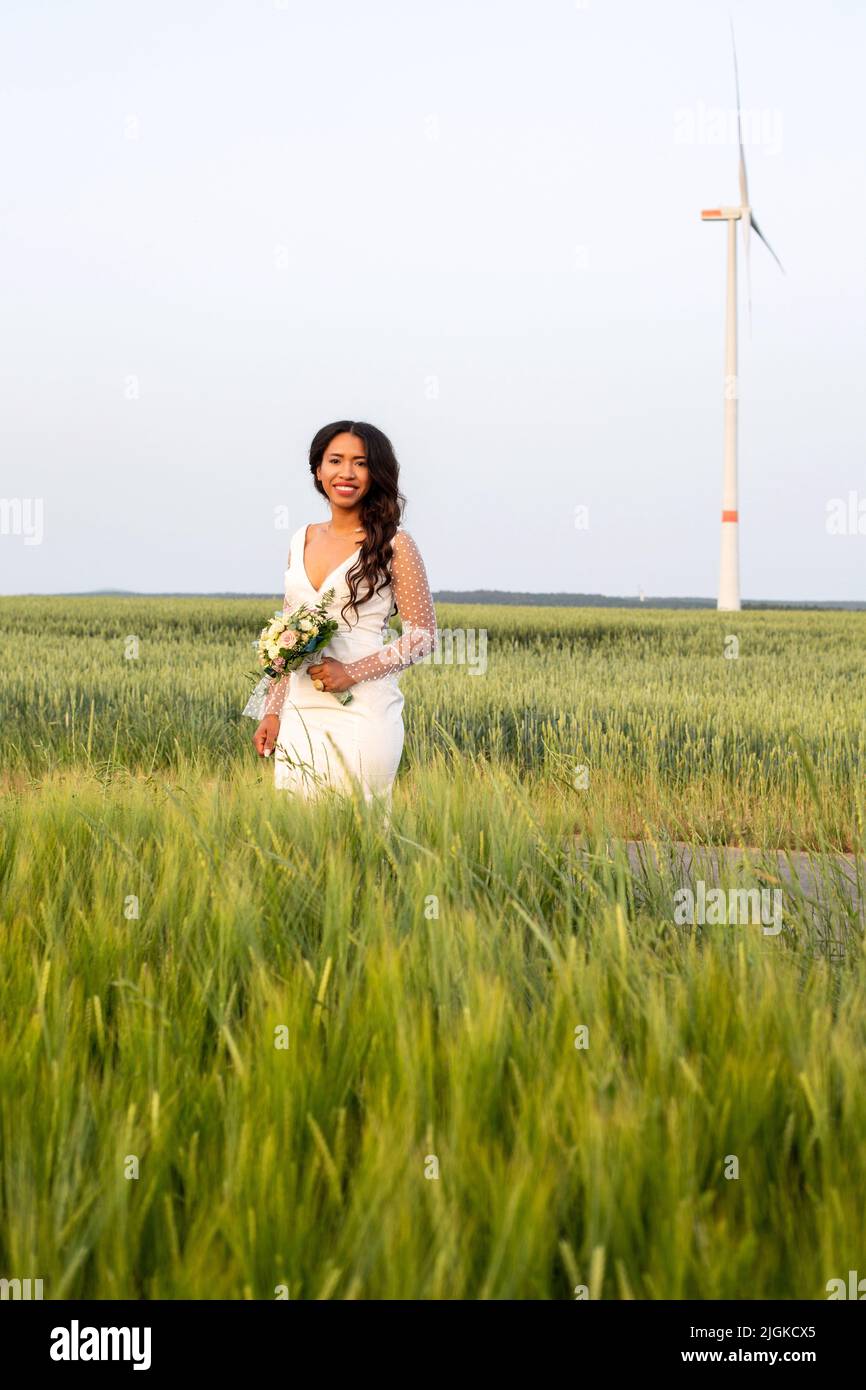 happy african-american bride standing in a field Stock Photo - Alamy