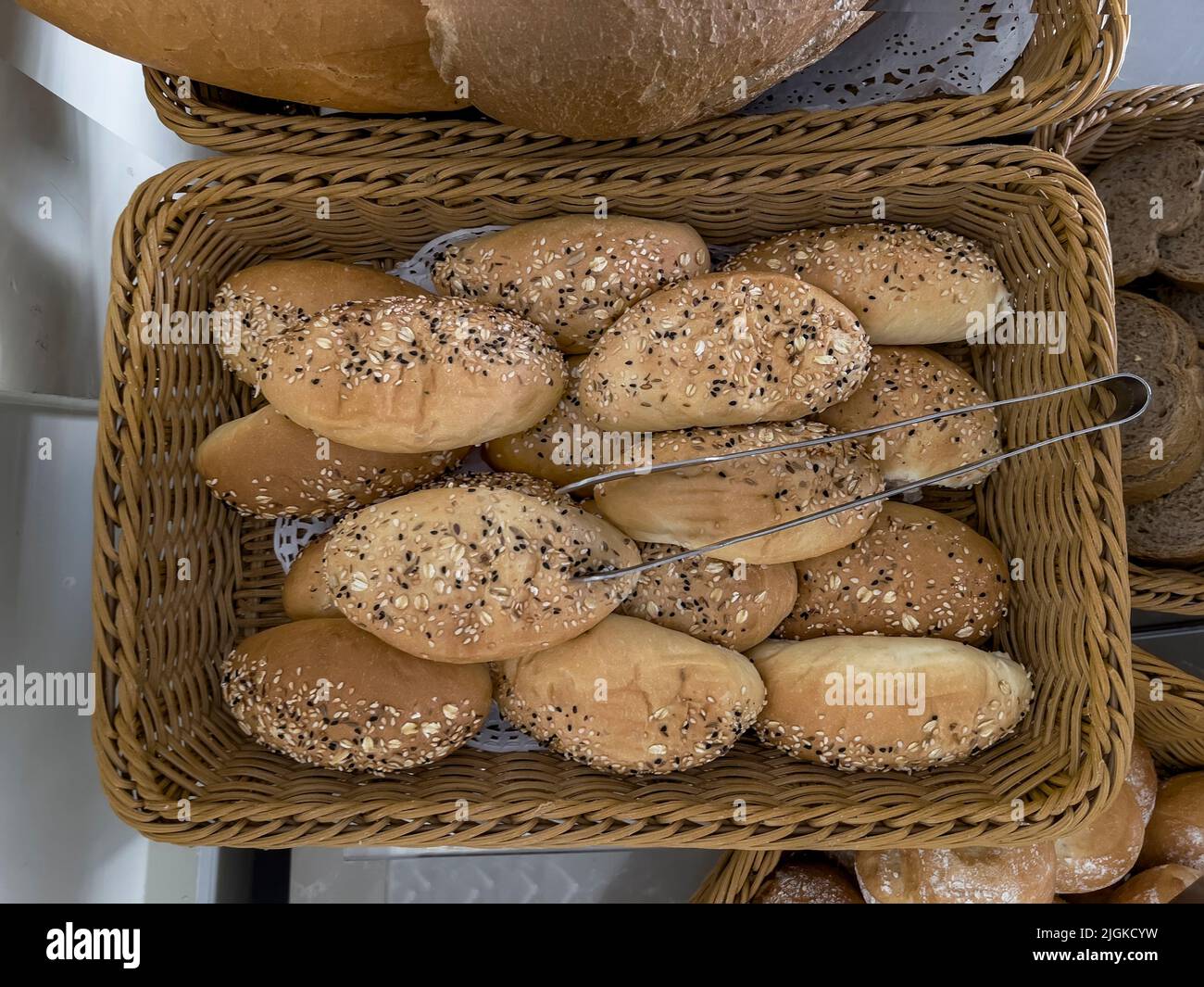 Delicious buns are on the table in a wicker basket. Top view, close-up ...
