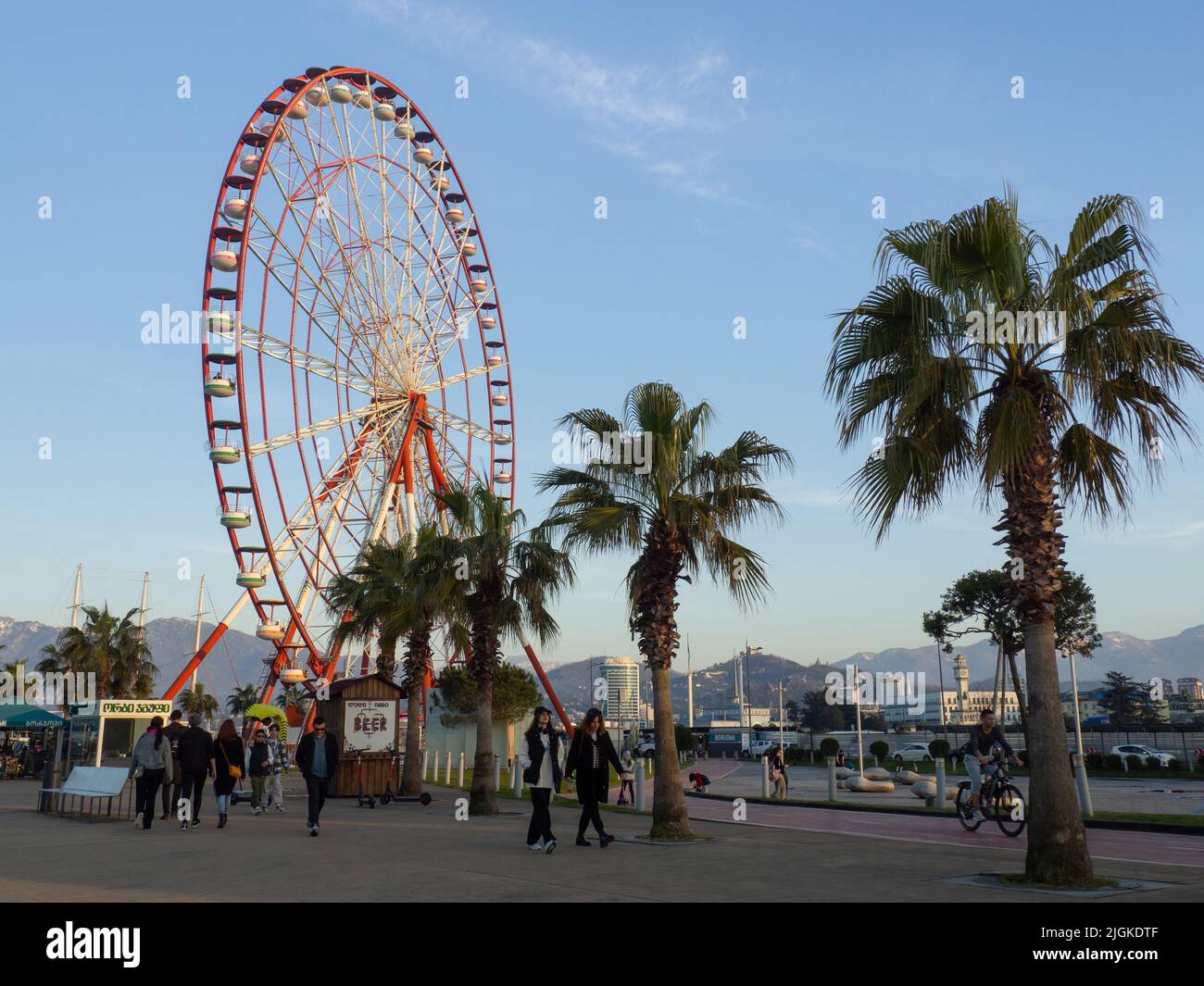 Ferris wheel against the sky. Amusement park on the sea. Rest zone ...