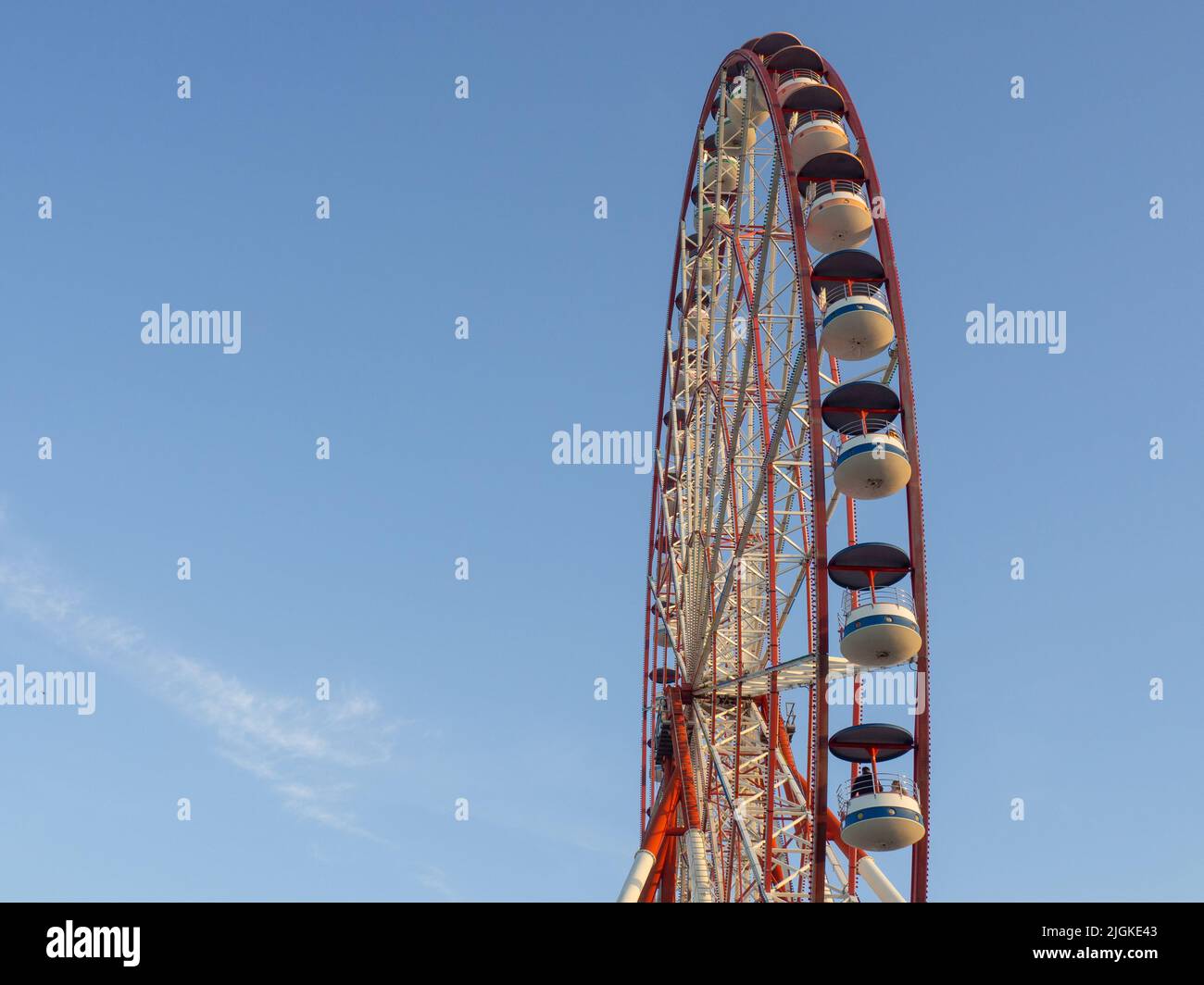 Ferris wheel against the sky. Amusement park on the sea. Rest zone ...
