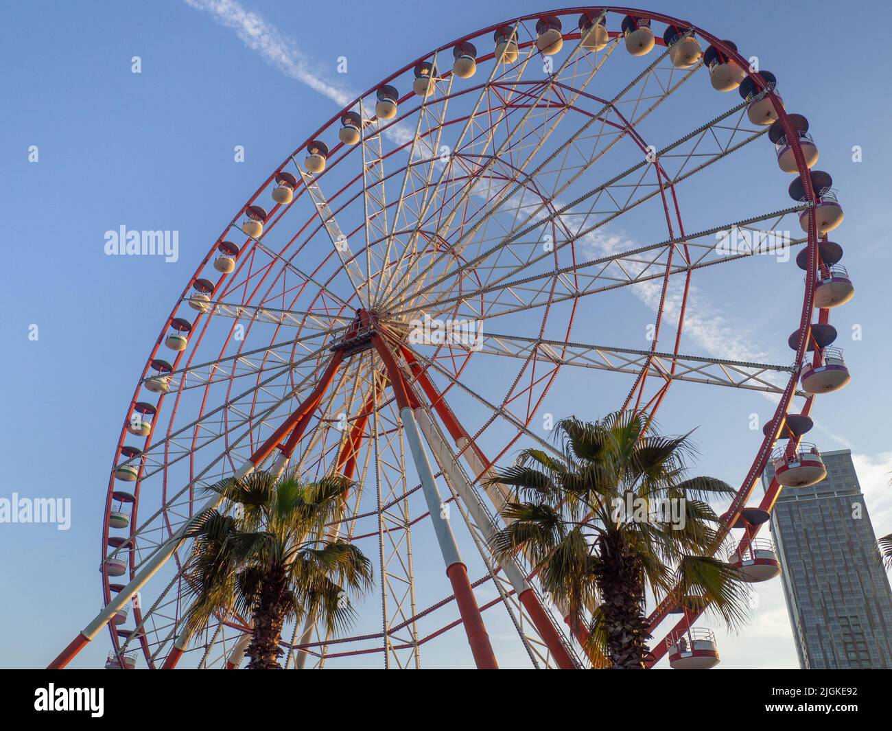 Ferris wheel against the sky. Amusement park on the sea. Rest zone ...