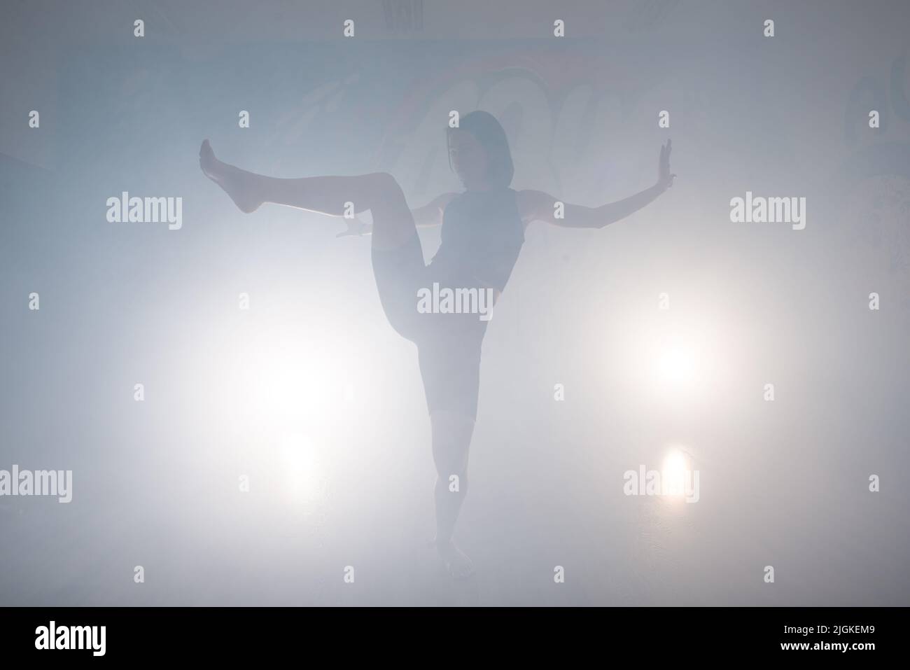 Group of multiracial dancers enjoying funky hip hop moves in dark ...