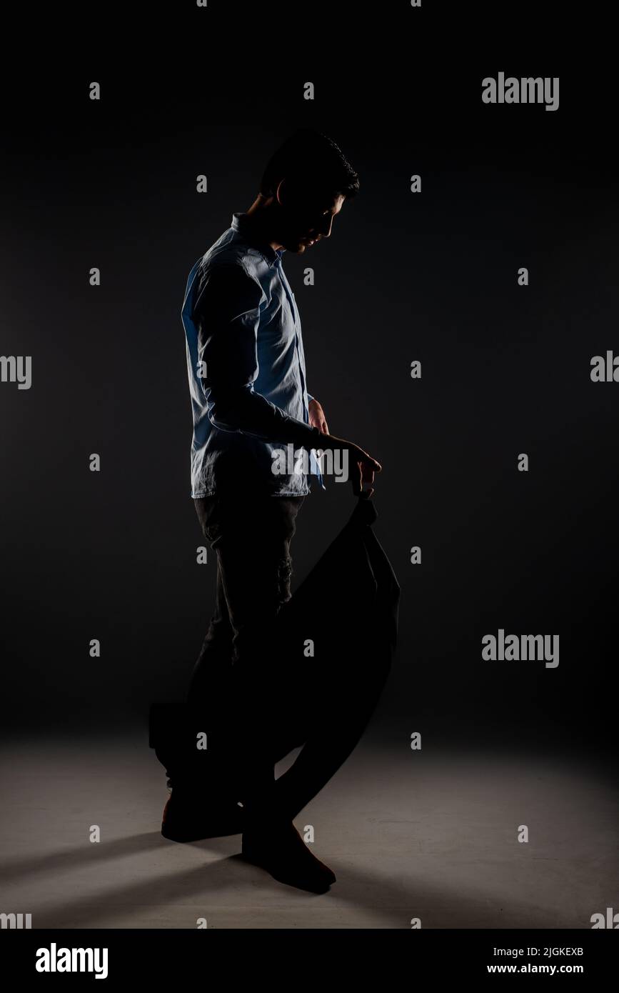 Sideview of an handsome model doing different poses inside the studio ...