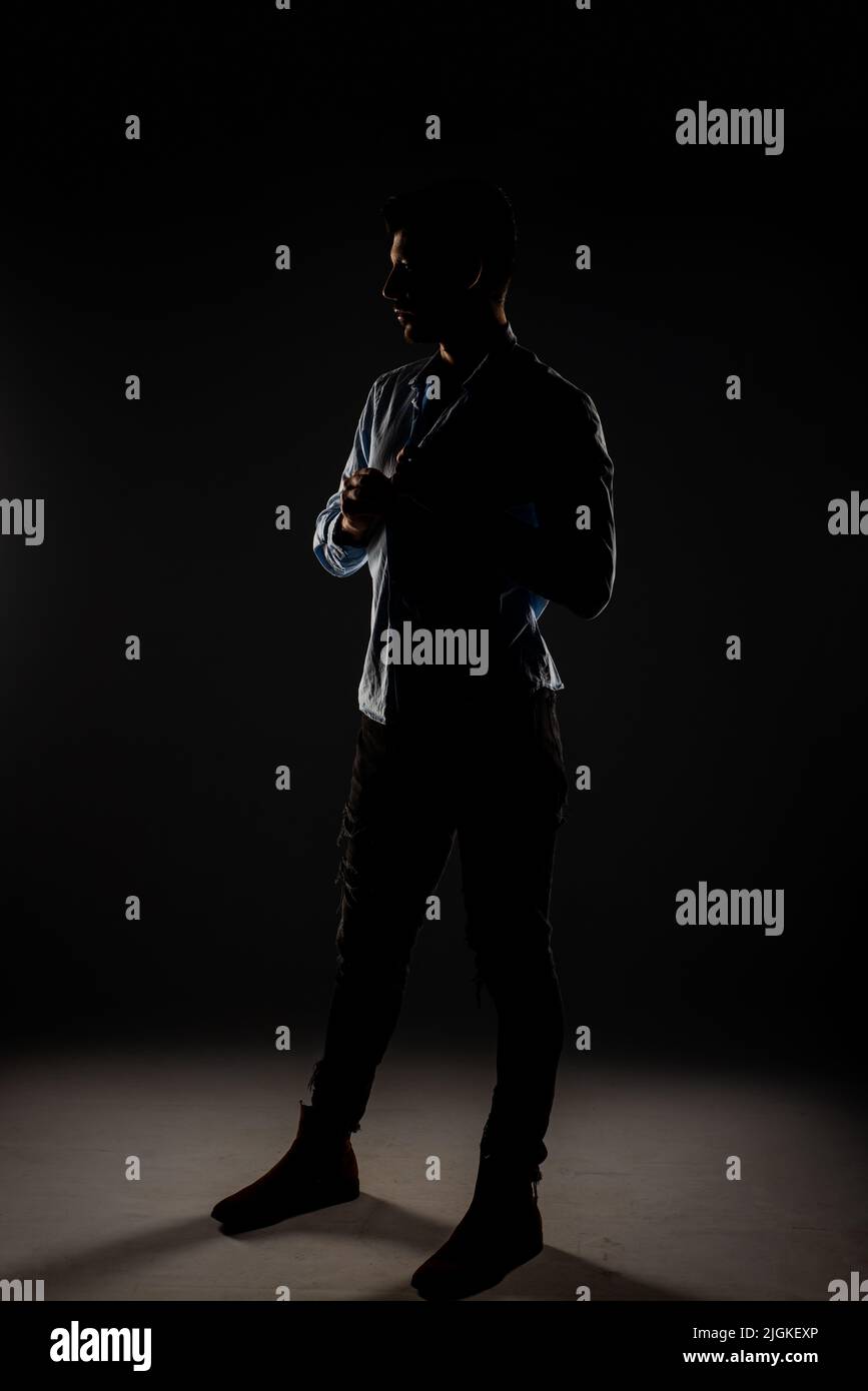 Sideview of an handsome model doing different poses inside the studio ...