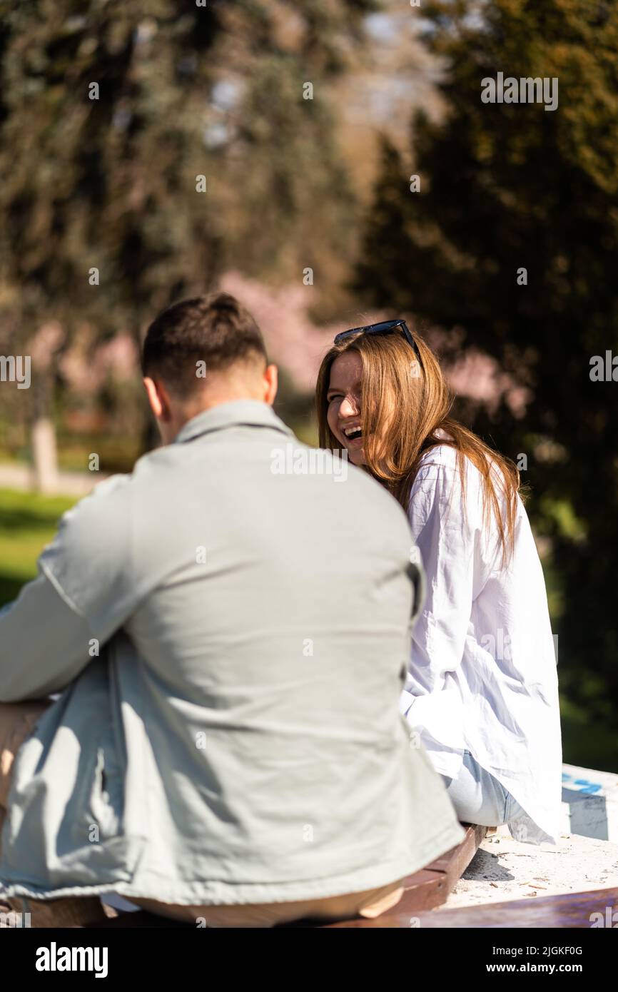 Two smiling friends talking to each other while enjoying in beautiful ...