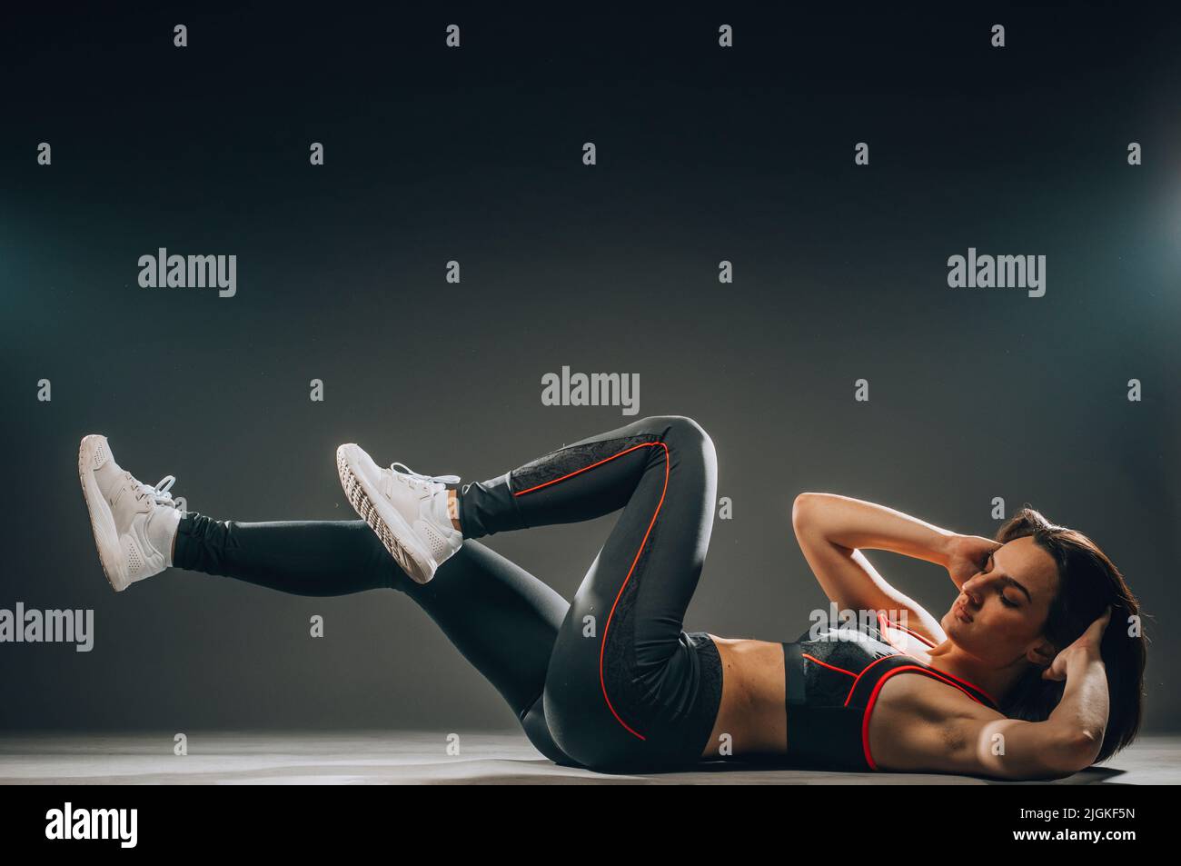 Slim athletic woman doing fitness stretching exercises and pushups ...