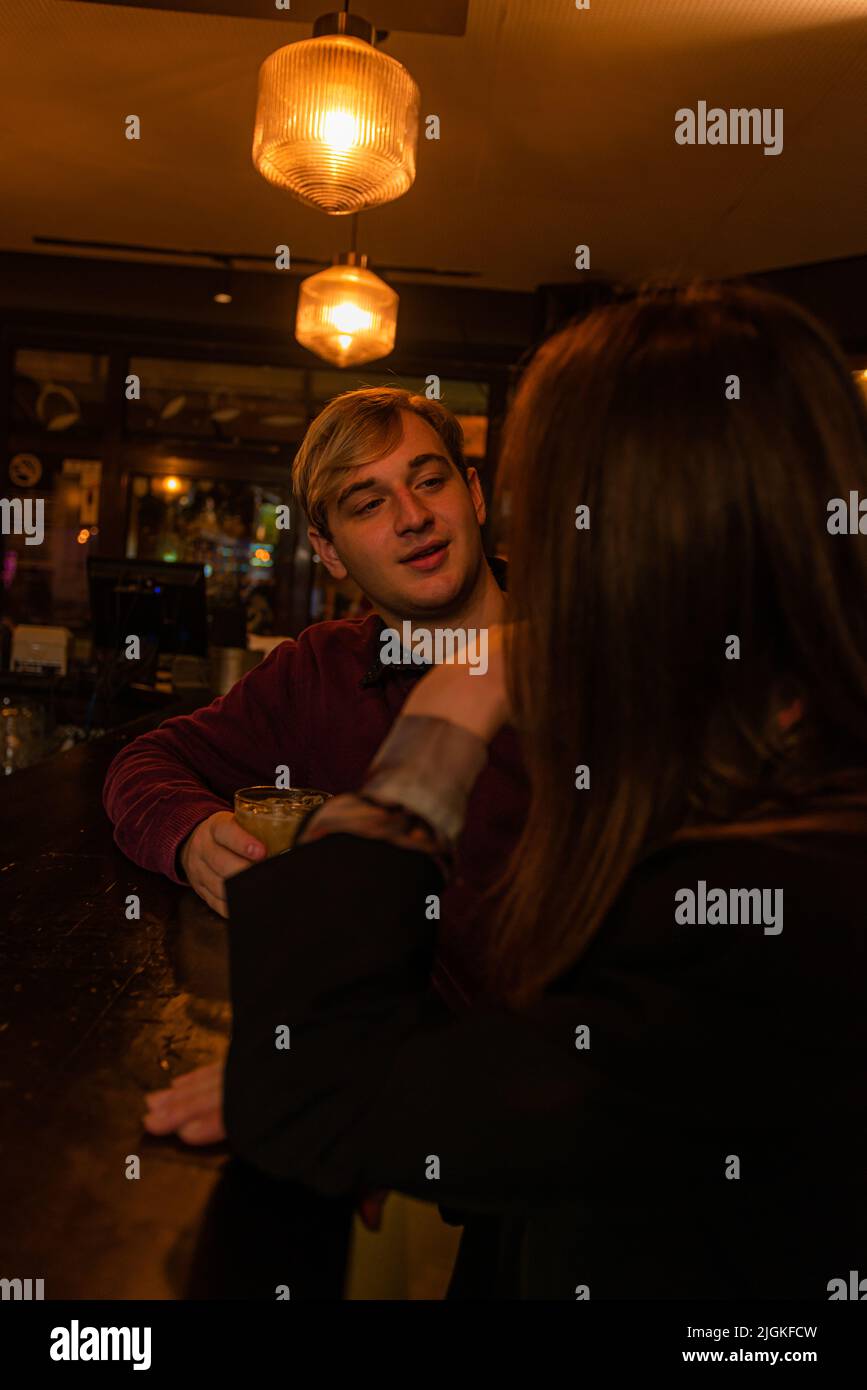 Two attractive and beautiful people are flirting with each other on the ...