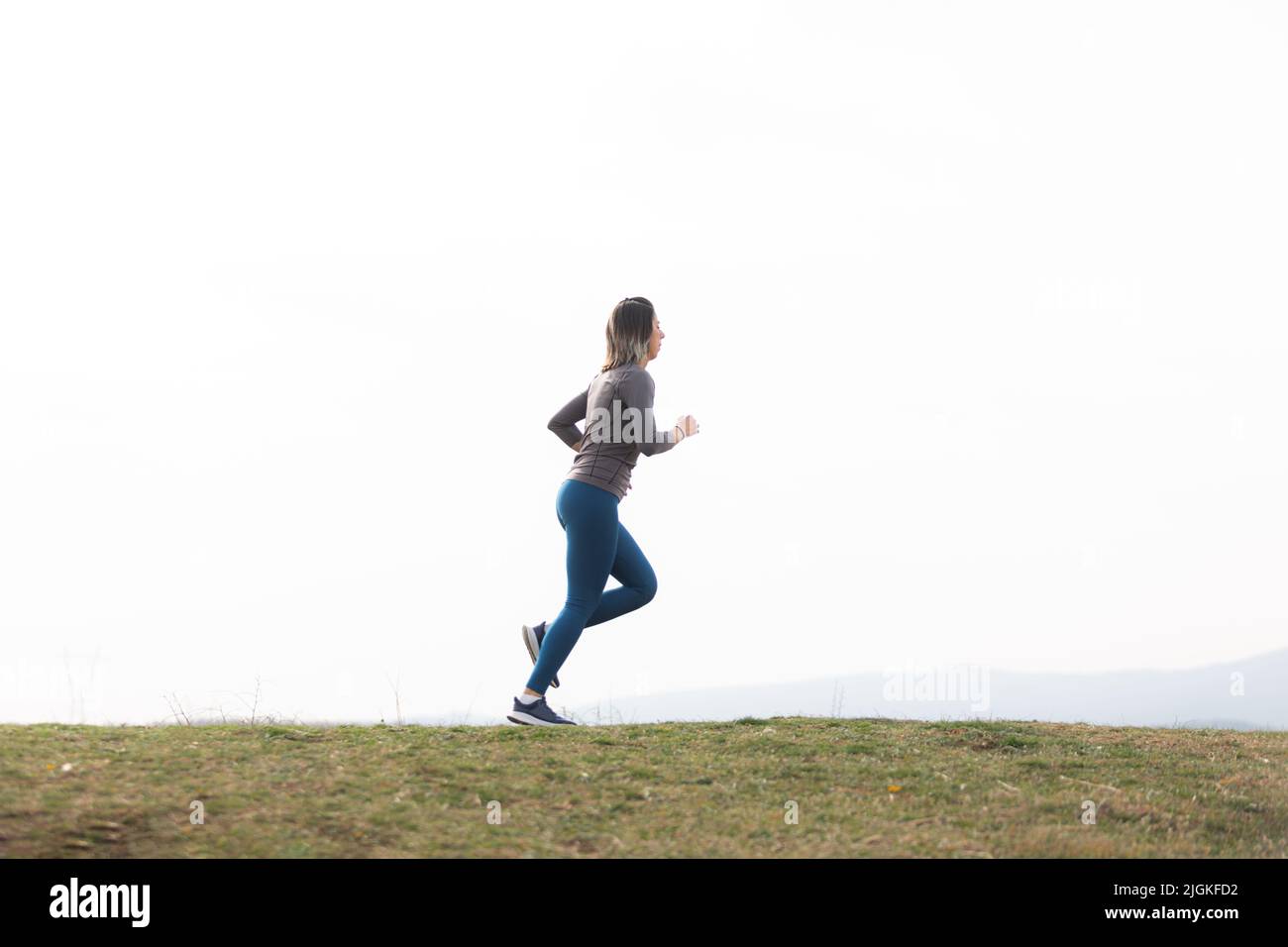 Amazing and active woman is running fast to warm up Stock Photo - Alamy
