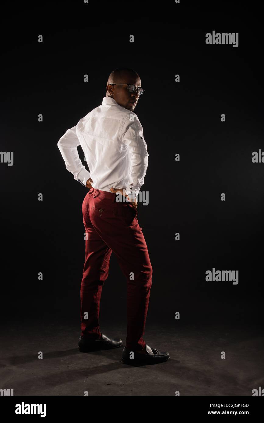 Africna black male is posing with his back in studio Stock Photo - Alamy