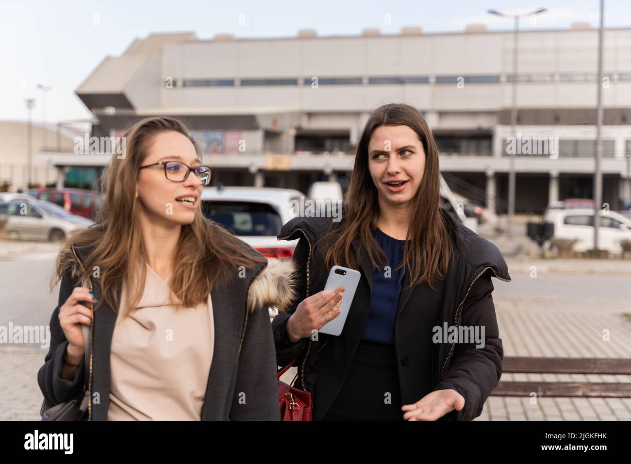 Two amazing and attractive businesswomen are having a serious talk ...