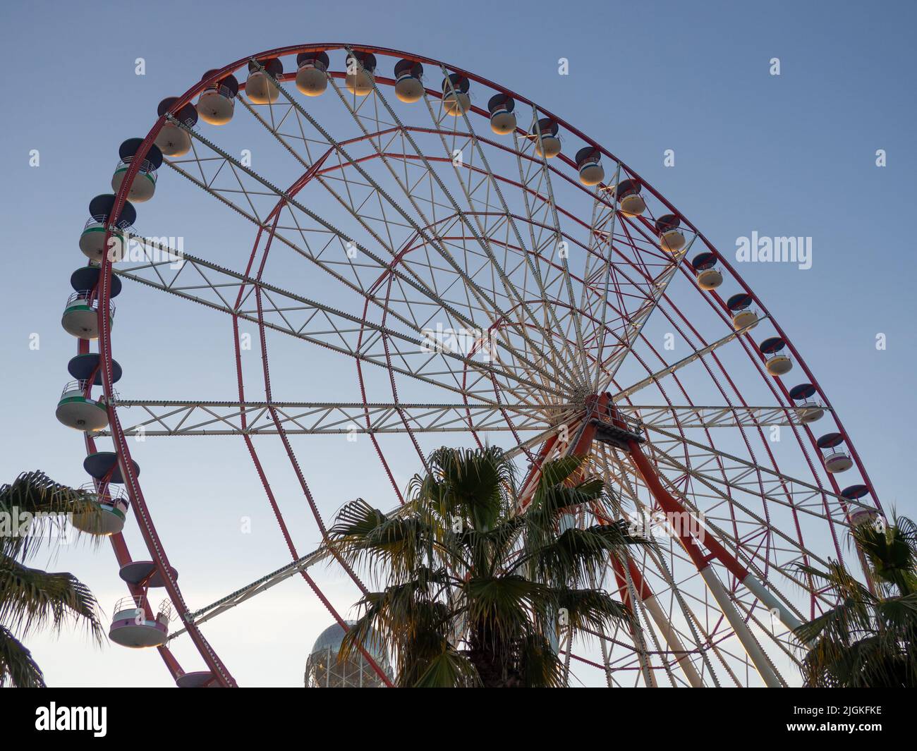 Ferris wheel against the sky. Amusement park by the sea. Rest zone ...