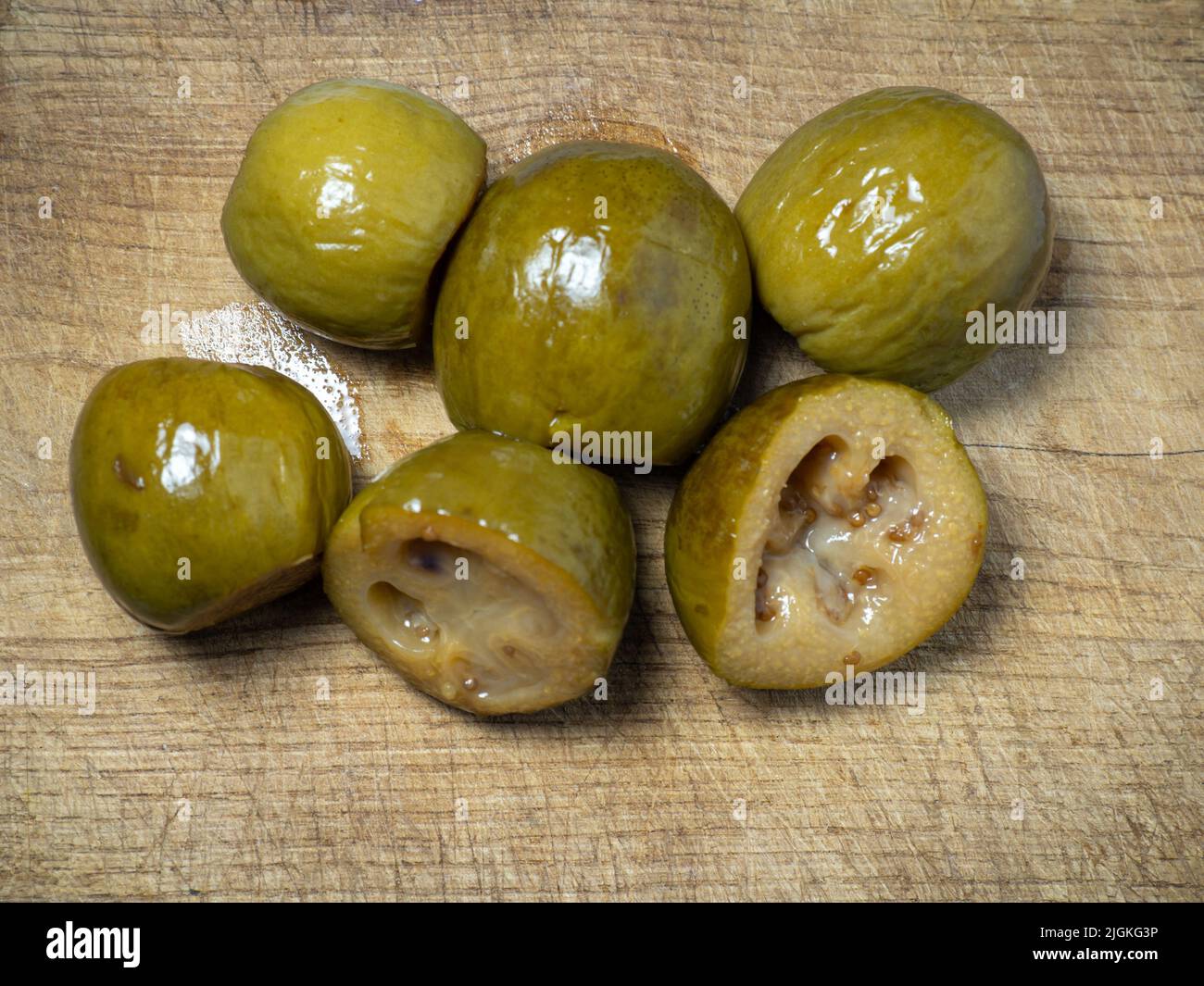 Canned feijoa. The fruit of a tree with seeds. Compote preparation. Cut ...