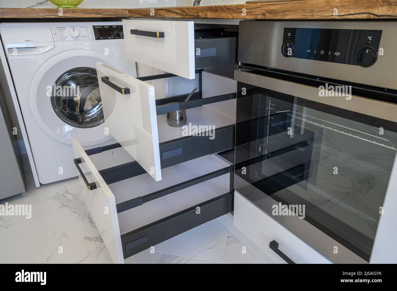 White and wooden modern kitchen furniture, some drawers open Stock ...