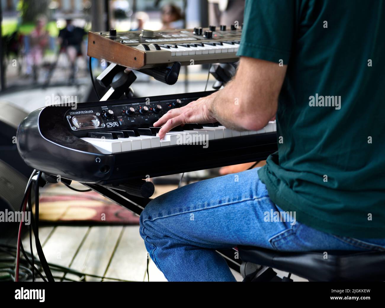 A musician plays a Stage Vintage brand portable keyboard during an ...