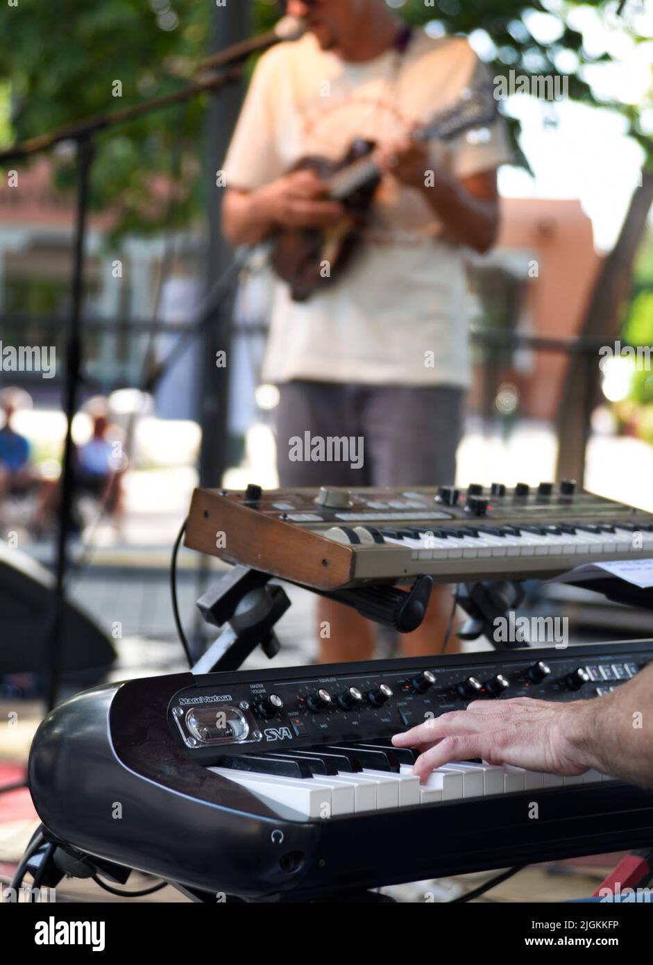 A musician plays a Stage Vintage brand portable keyboard during an ...