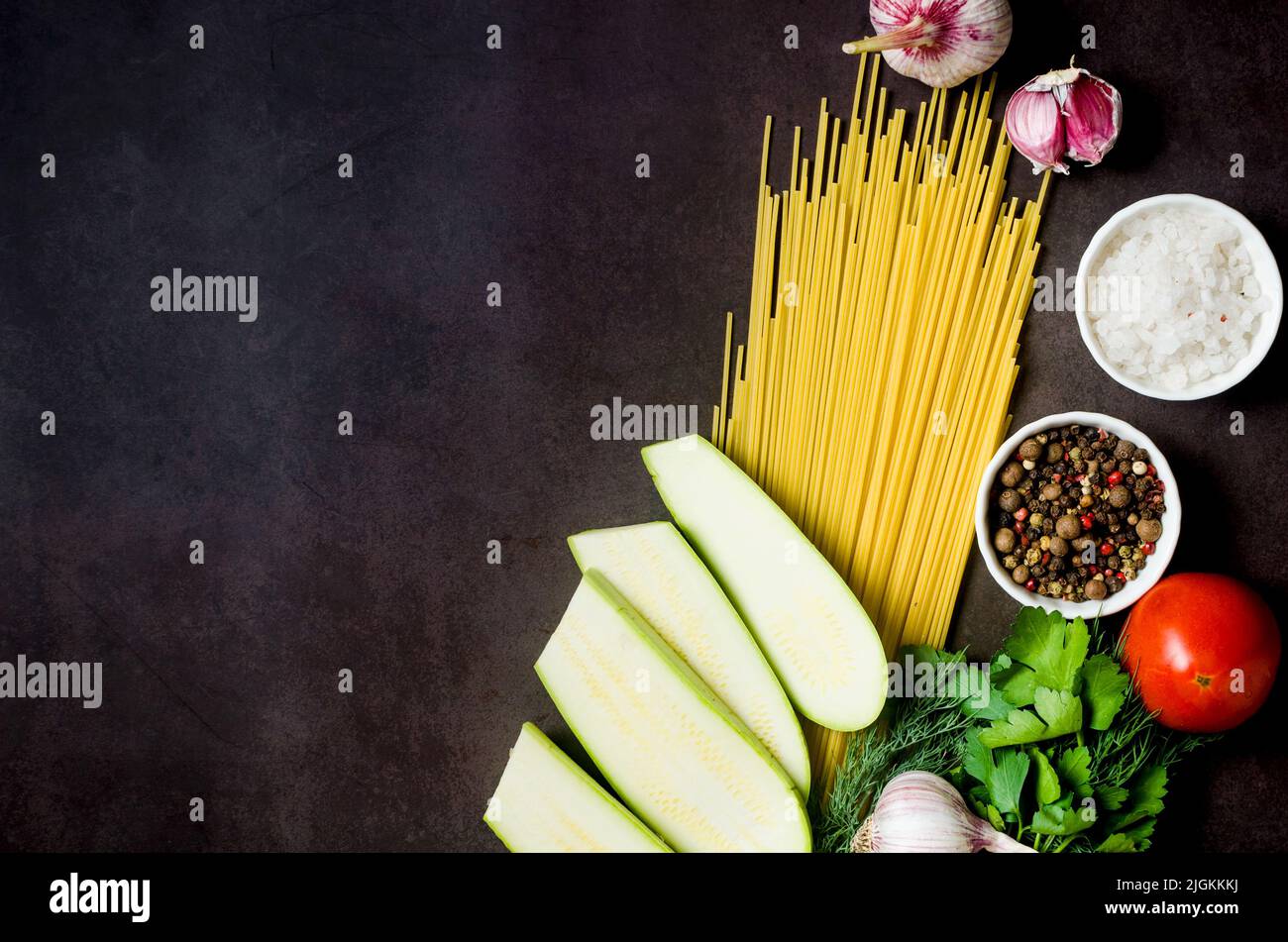 Raw long spaghetti with ingredients for cooking, marrow, tomatoes ...