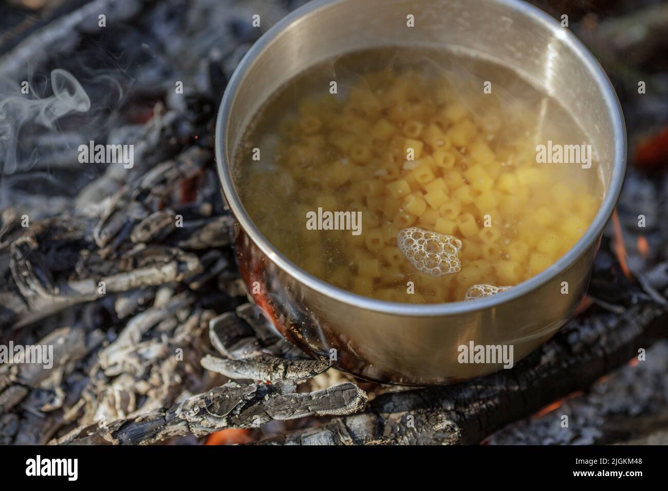 Cooking food in pot on campfire. The concept of adventure, travel ...