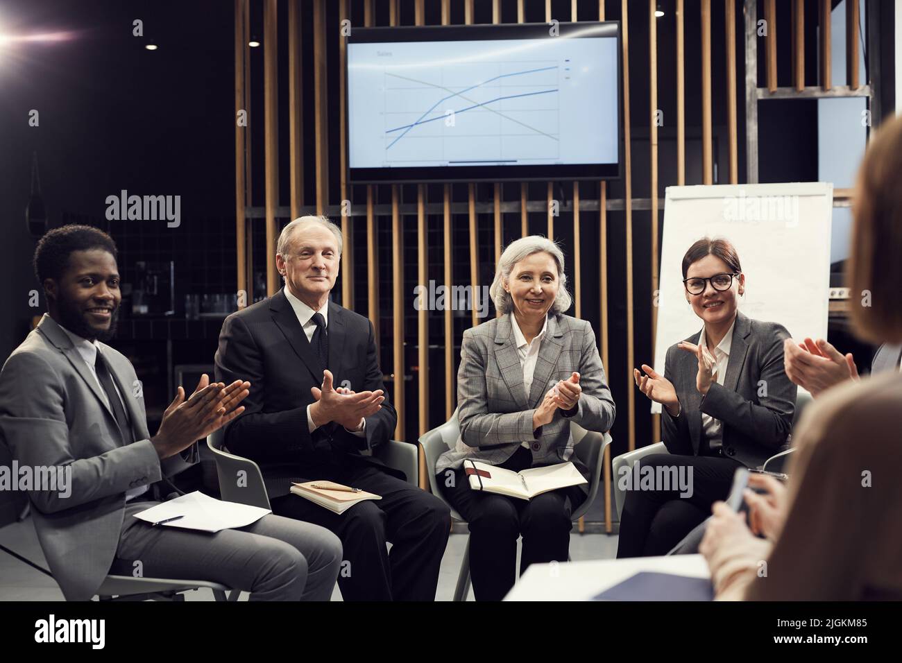 Group of excited multi-ethnic business people of different ages sitting ...