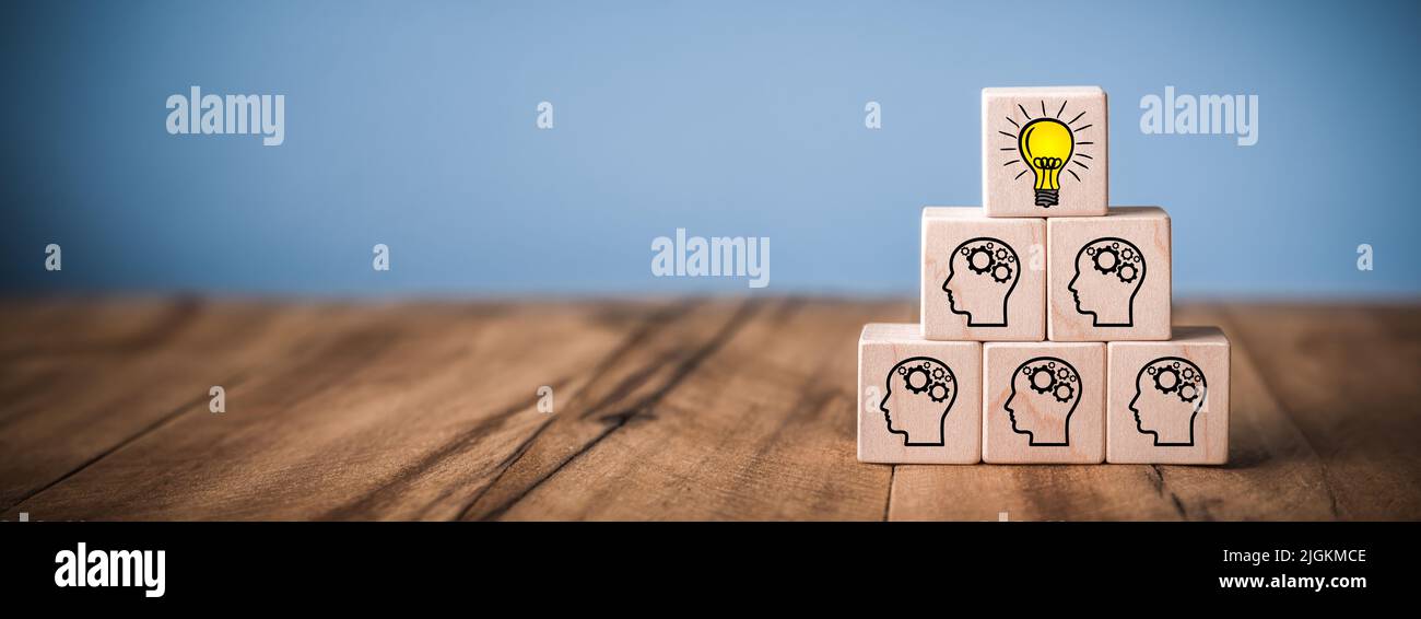 Wooden Blocks on Table With Team And Lightbulb Symbol - Success Through ...