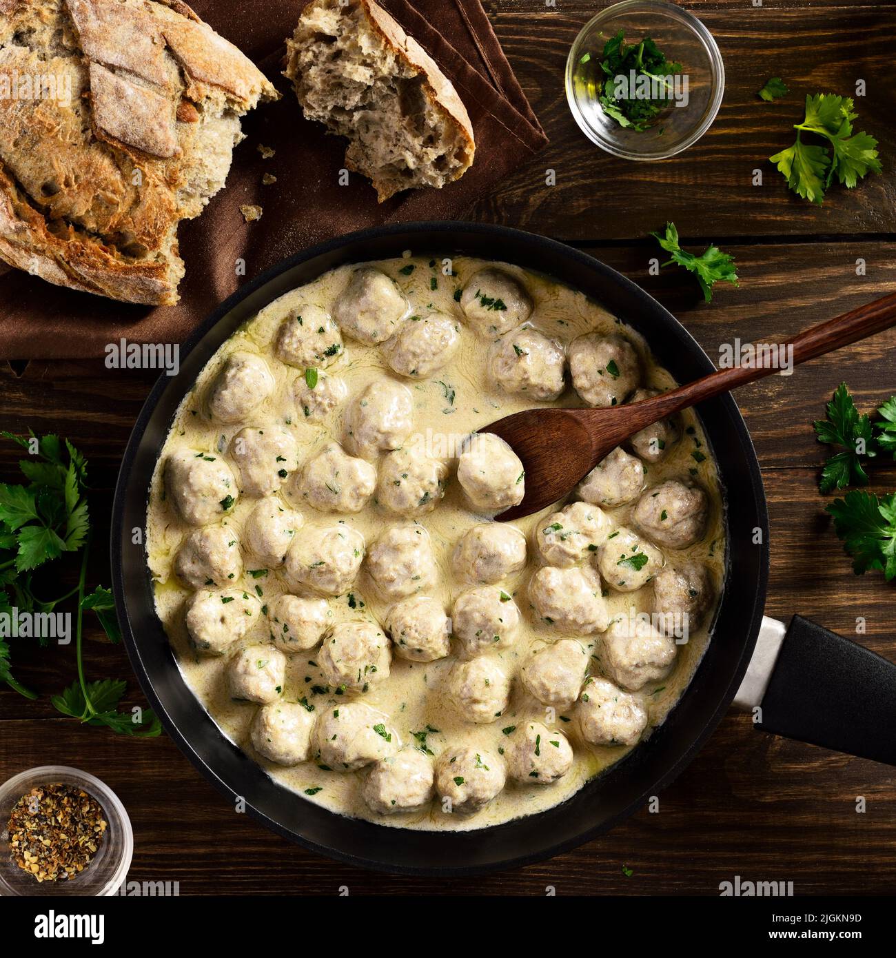 Close up view of swedish meatballs with creamy white sauce in cooking ...
