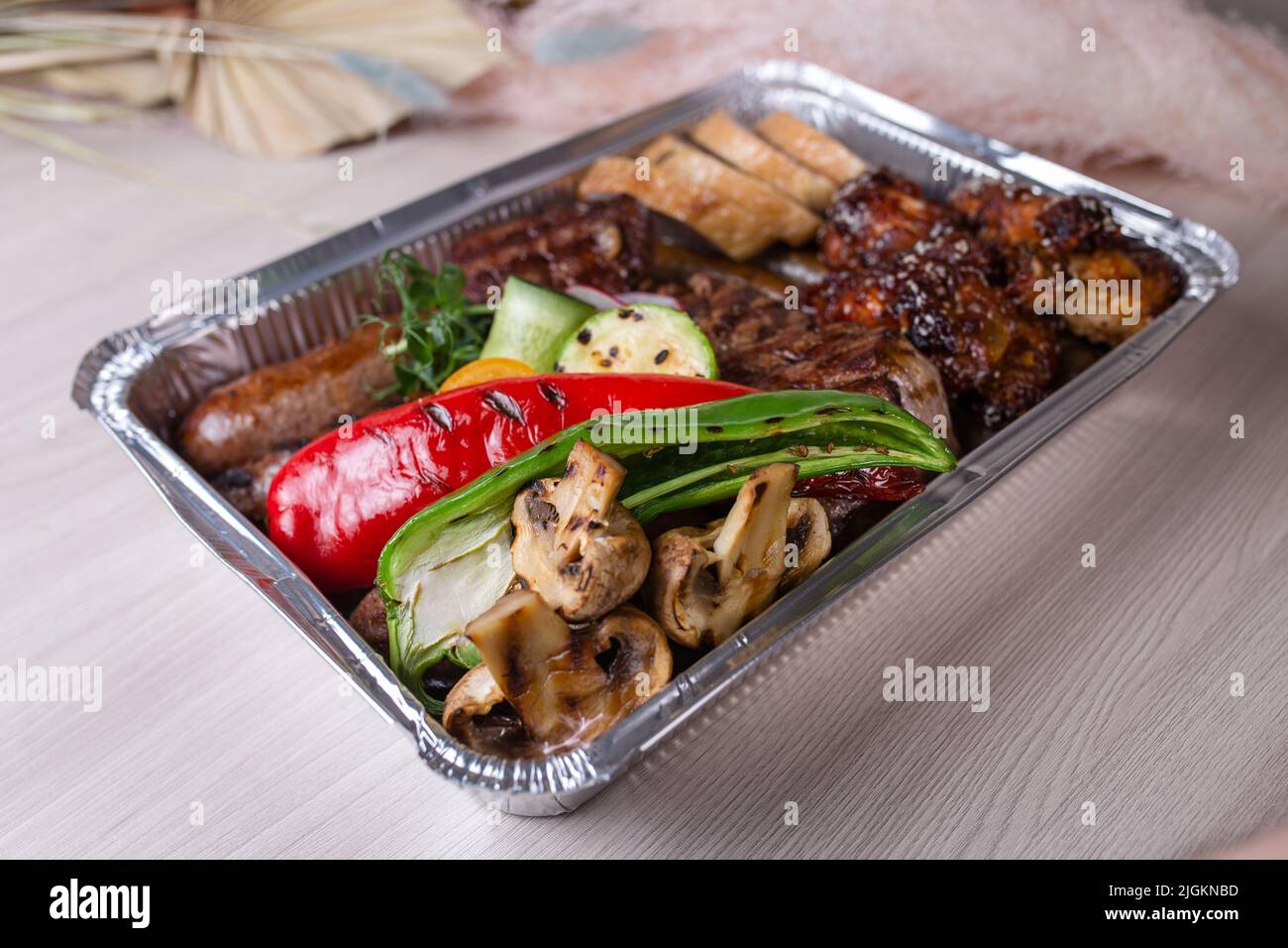 delivery of meat dishes in a foil box Stock Photo - Alamy