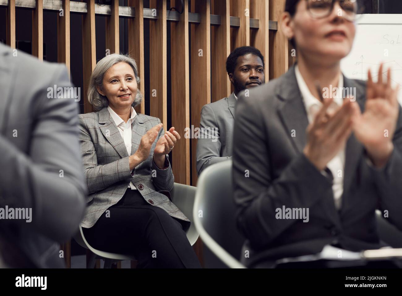 Group of positive multi-ethnic conference participants in formalwear ...